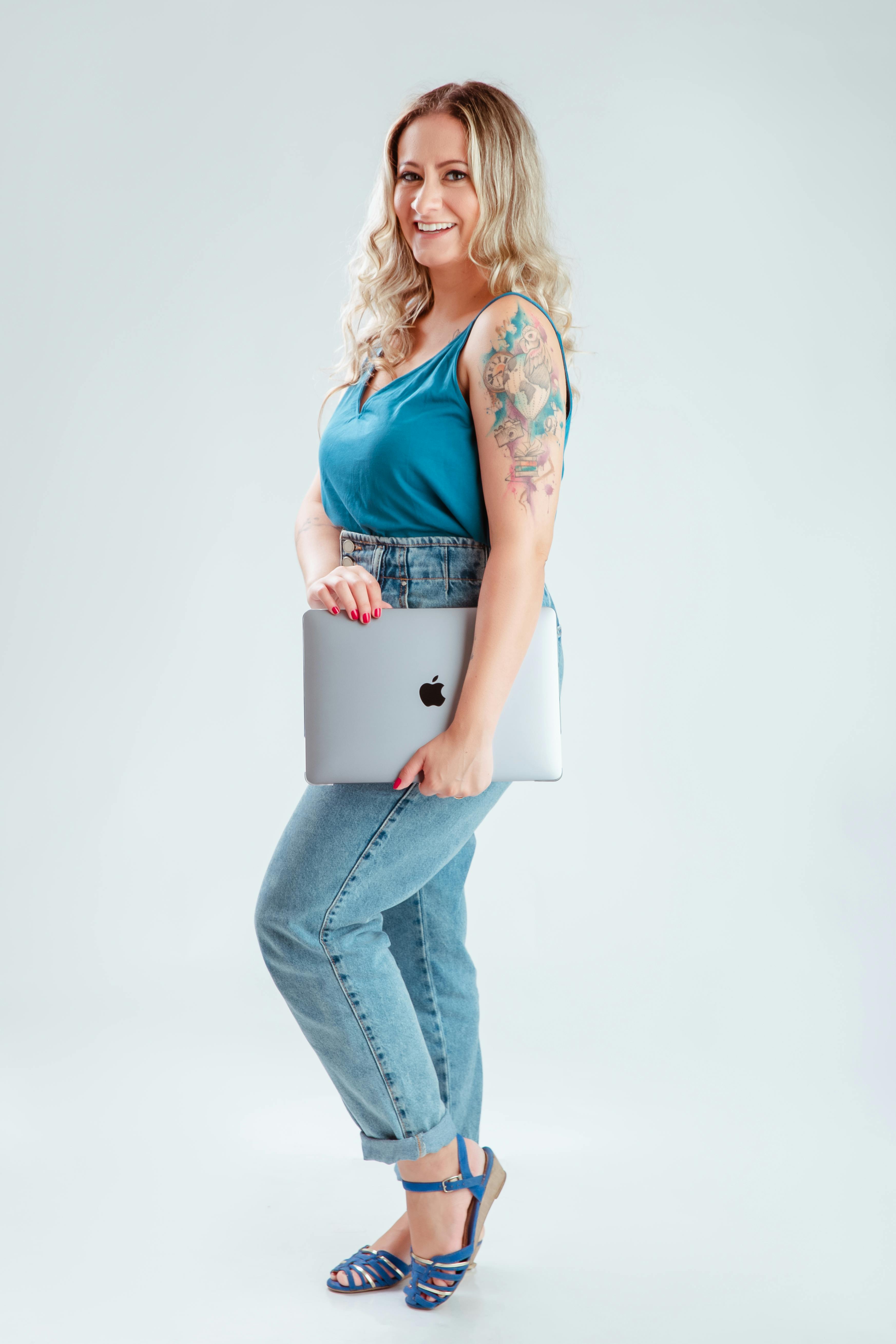 A Woman Standing While using Laptop · Free Stock Photo