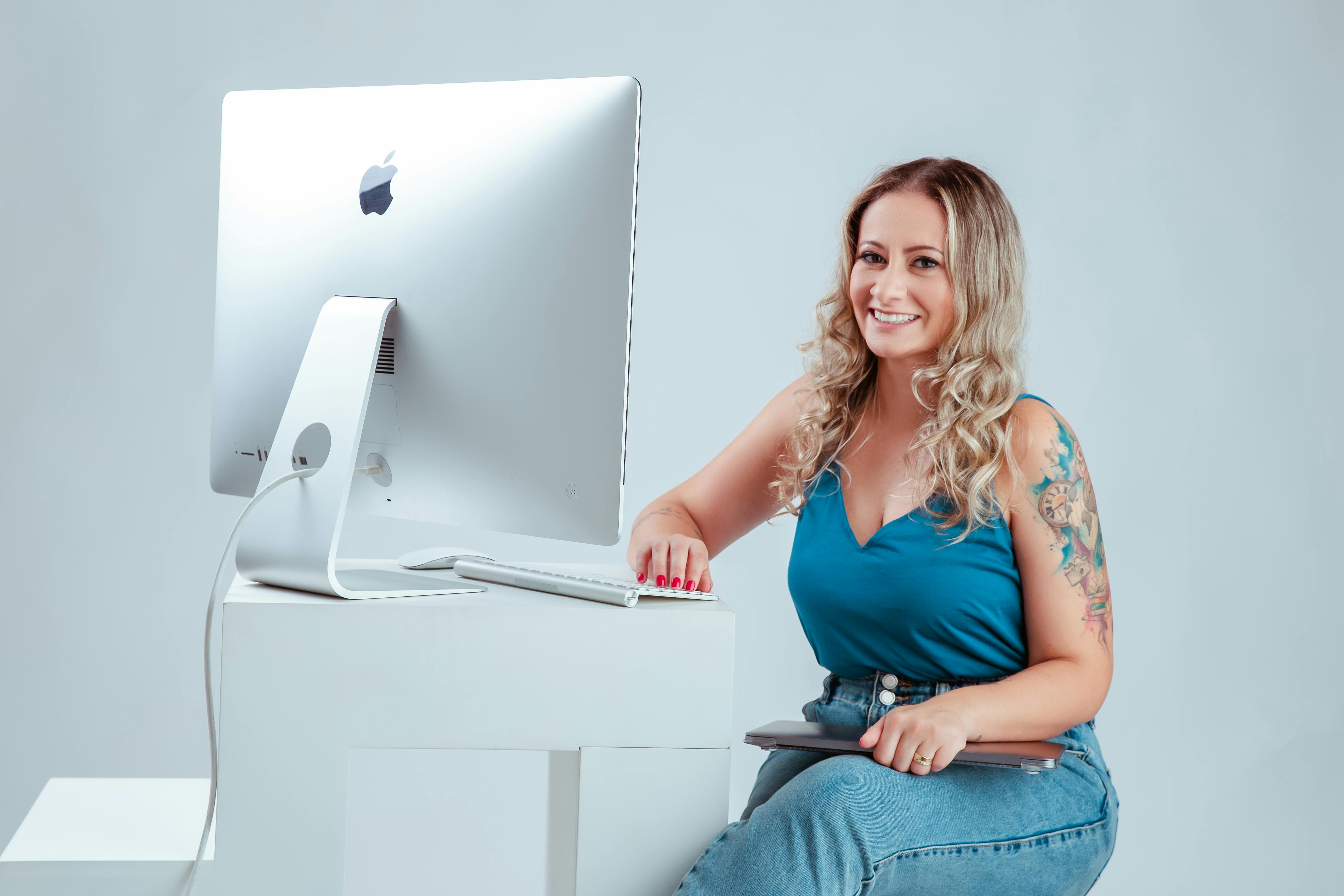 A Woman Standing While using Laptop · Free Stock Photo