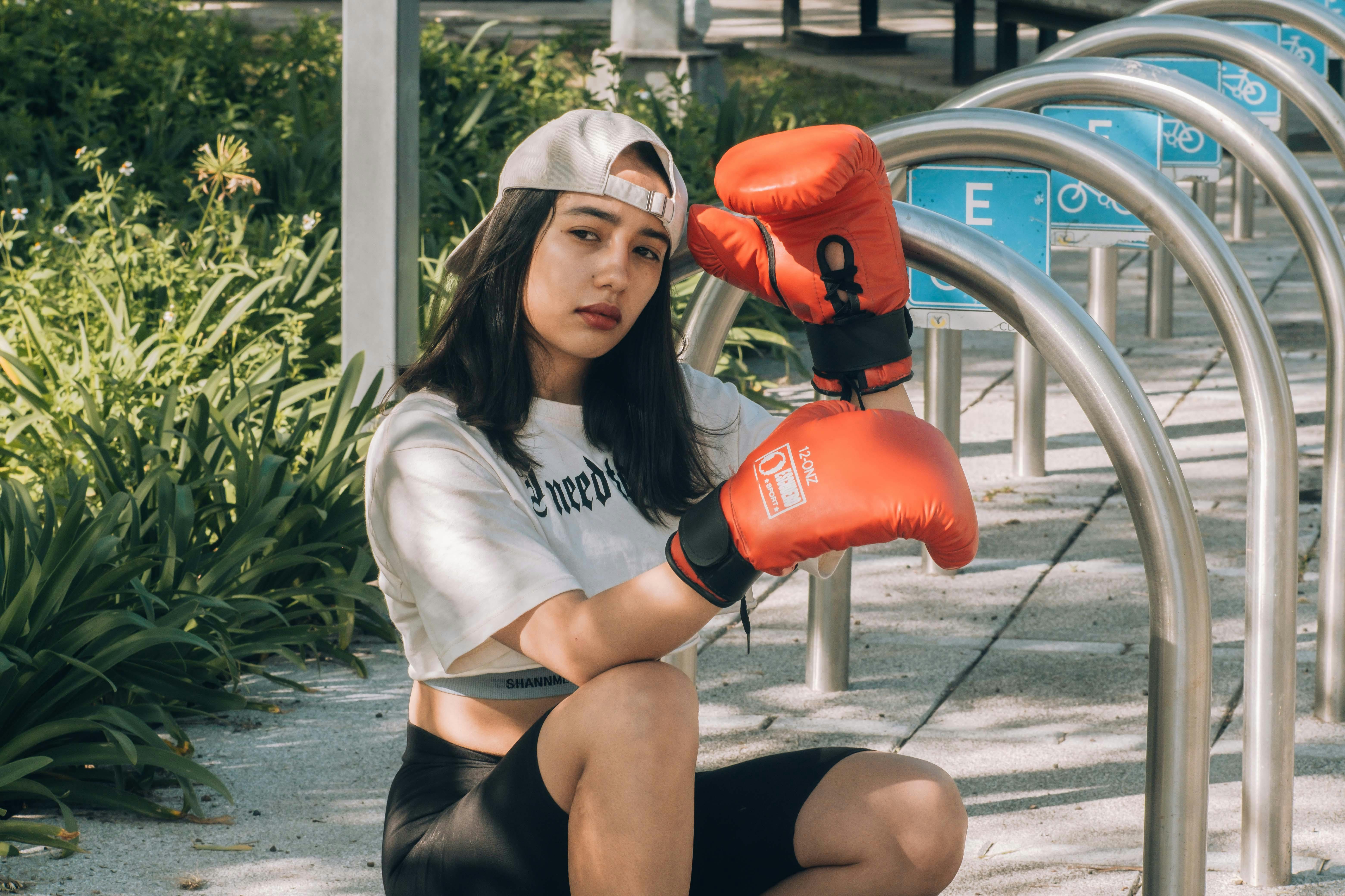 Woman in White Shirt Holding Red Boxing Gloves · Free Stock Photo