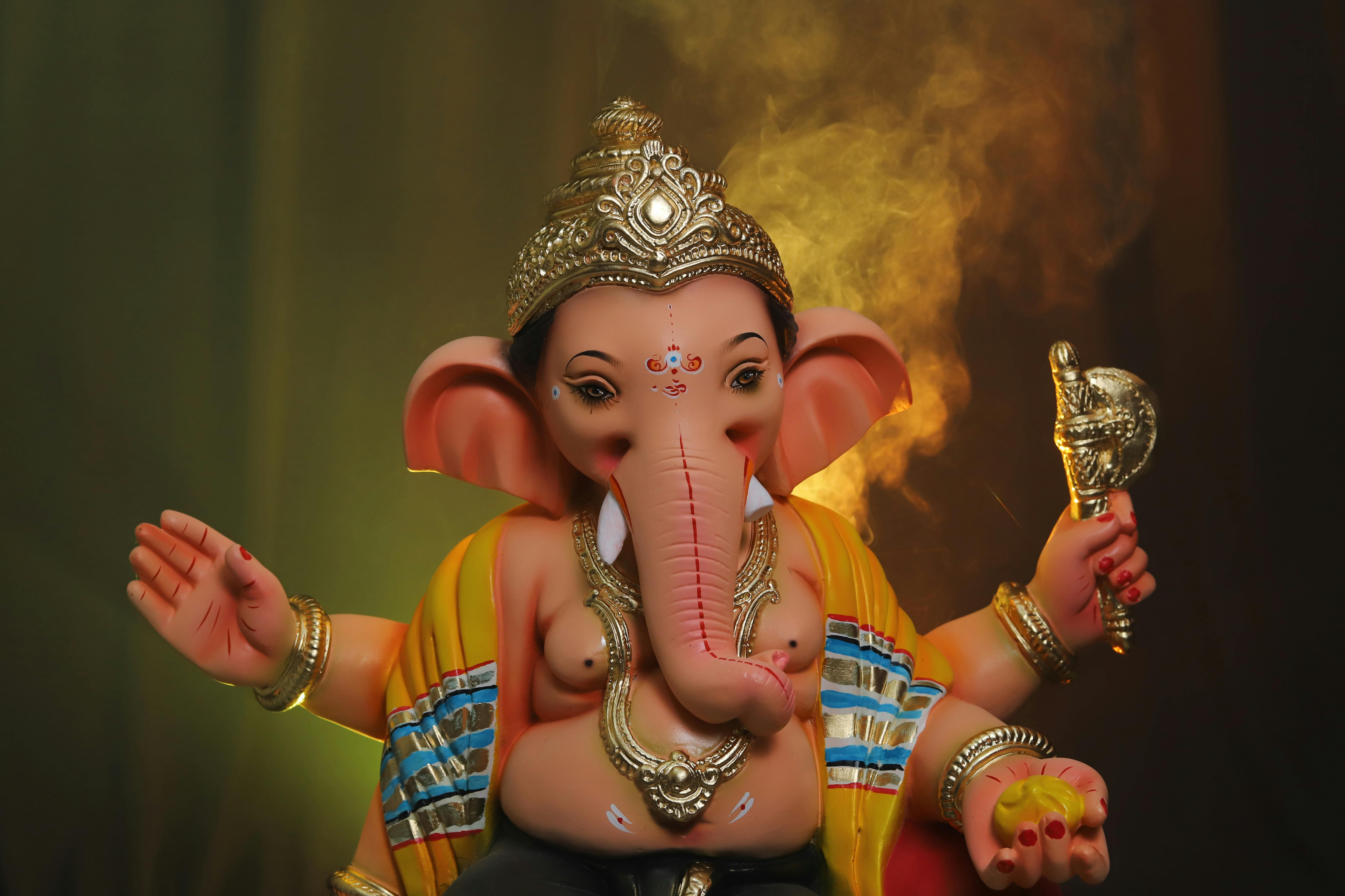 A Figurine of Ganesha on a Hand · Free Stock Photo