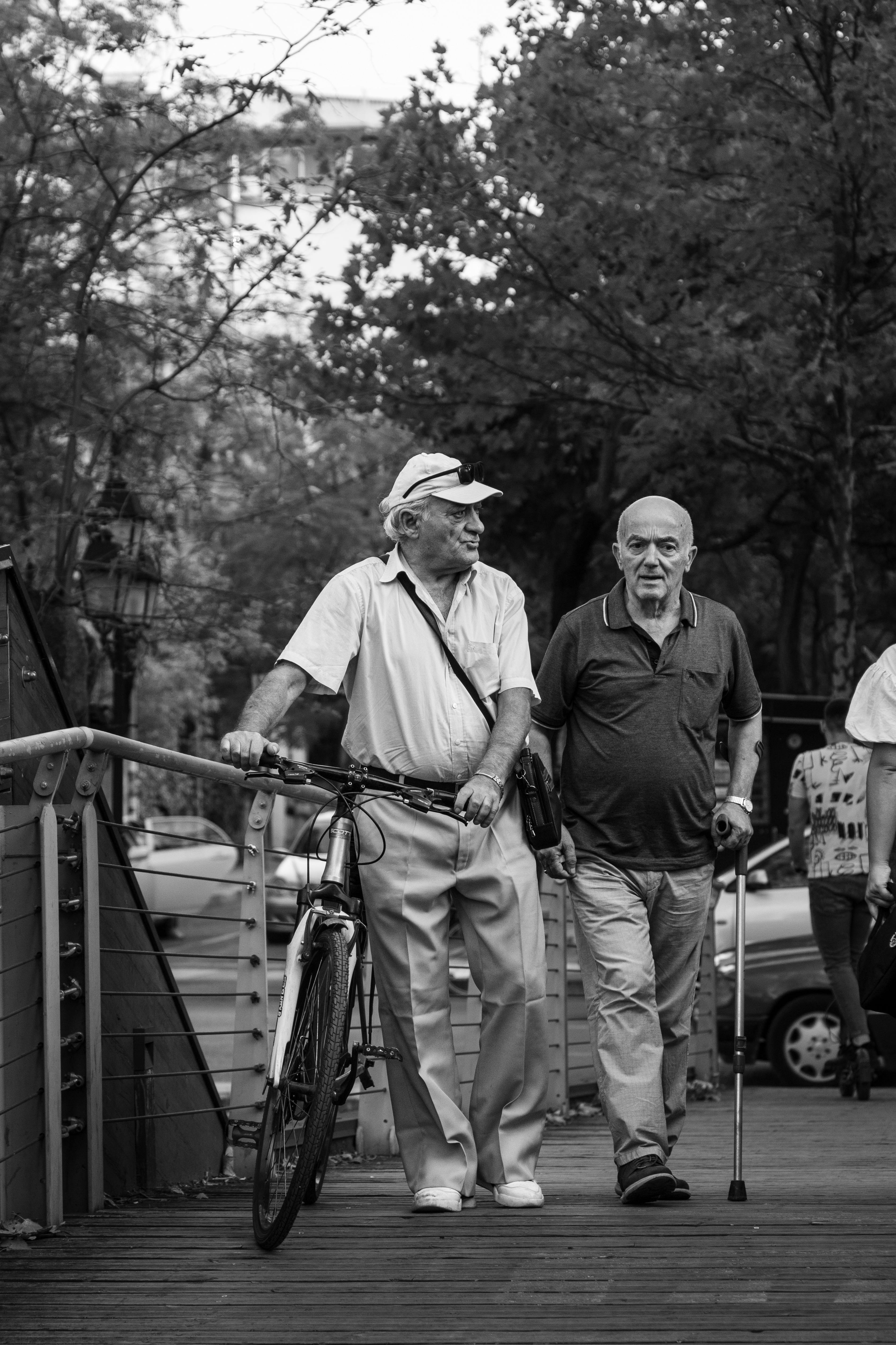 Grayscale Photo of Elderly Men Walking on the Street · Free Stock Photo