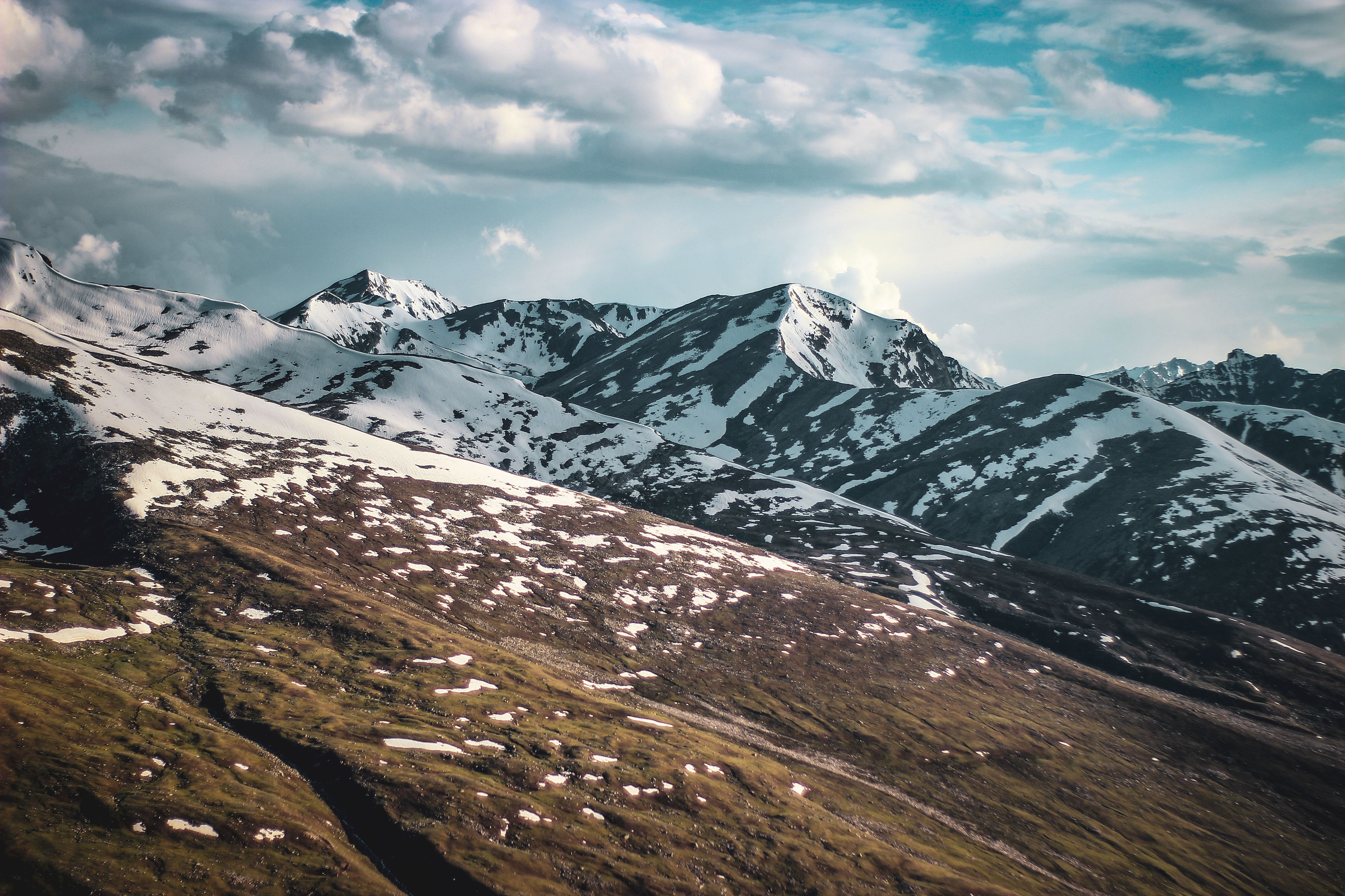 A Mountain with Snow Under Cloudy Sky · Free Stock Photo