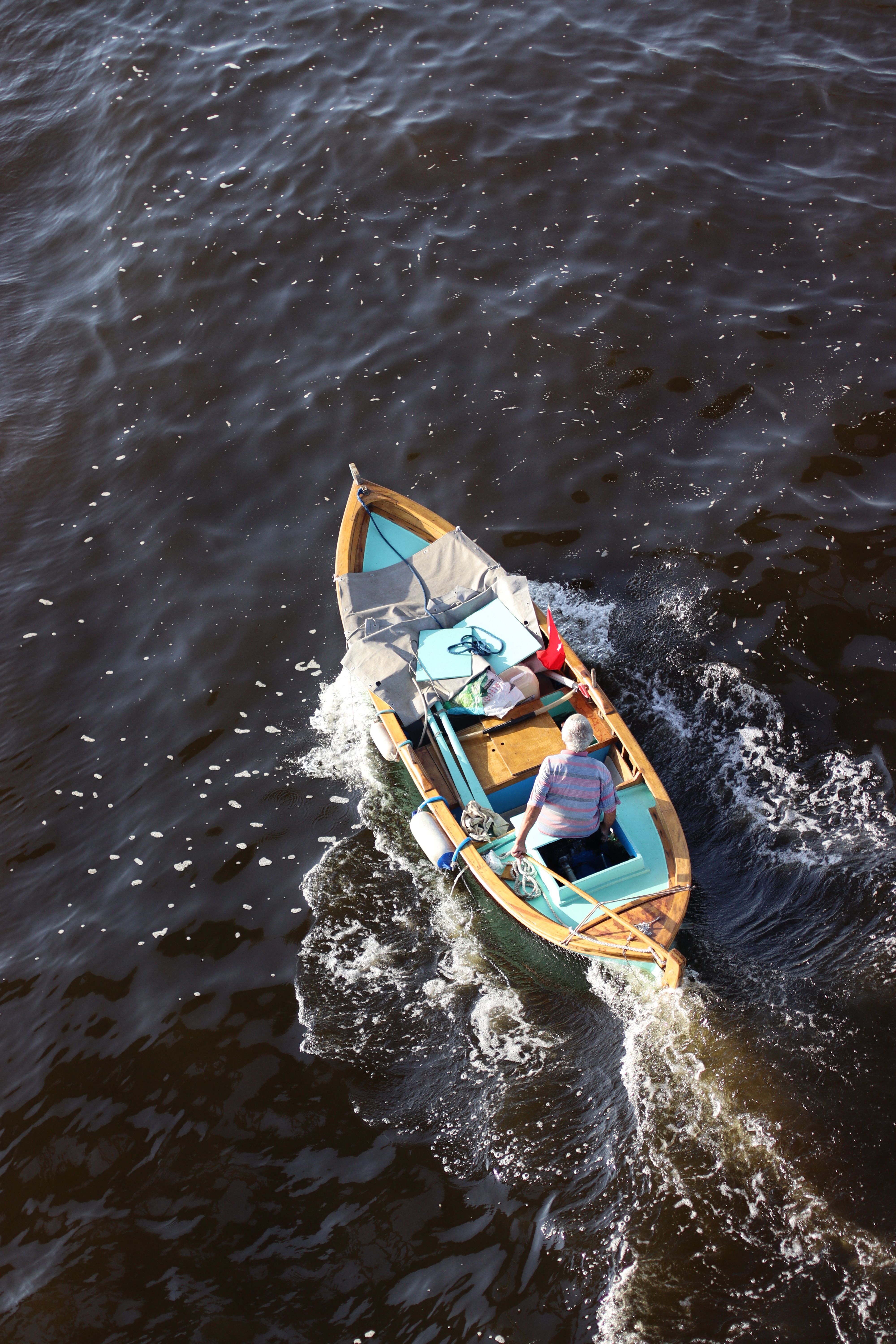 Man Paddling a Wooden Boat on the Lake · Free Stock Photo
