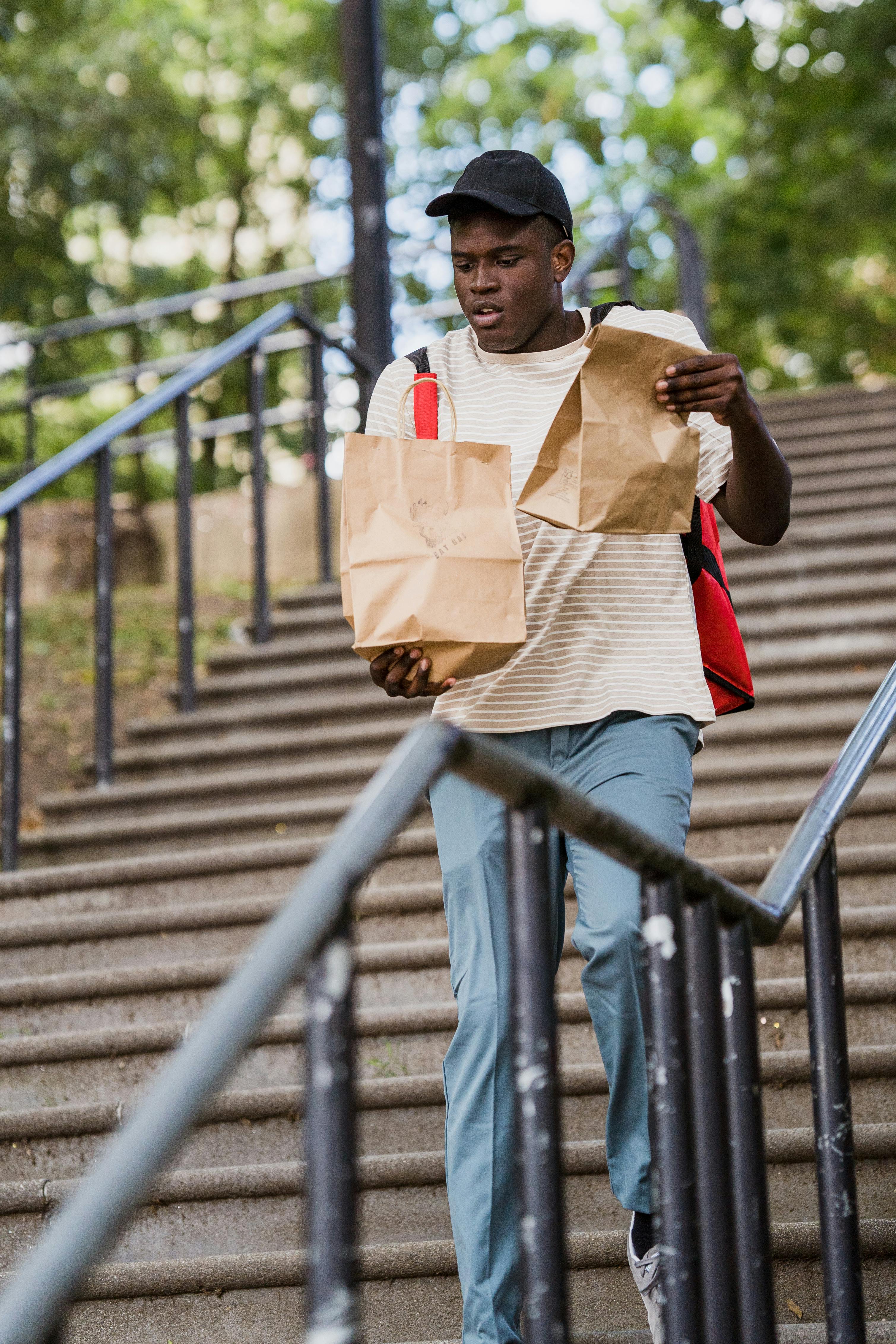 Courier with Backpack Delivering Order · Free Stock Photo