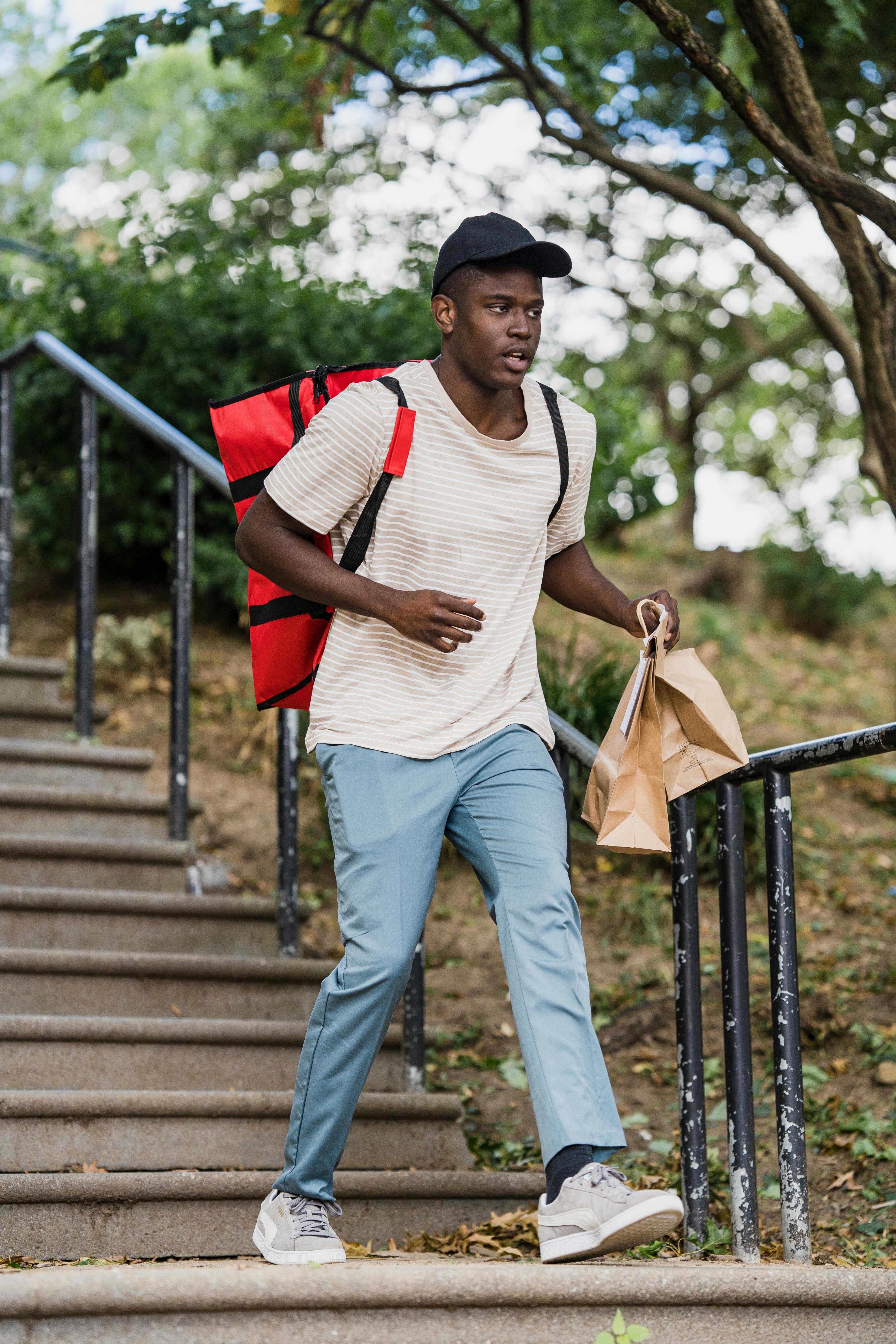 Guy with Backpack Walking with Bike · Free Stock Photo