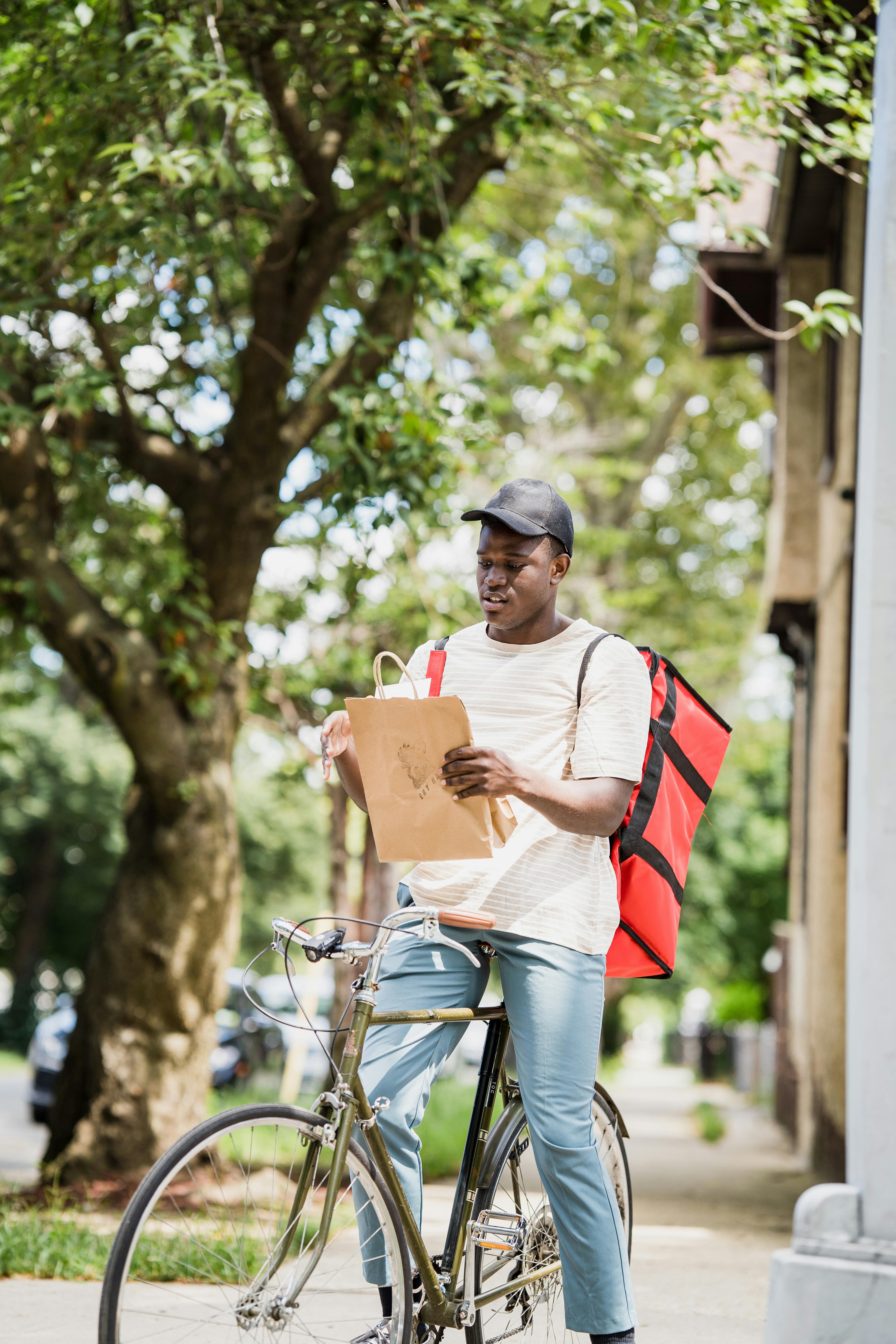 Deliveryman with Backpack Delivering Order · Free Stock Photo