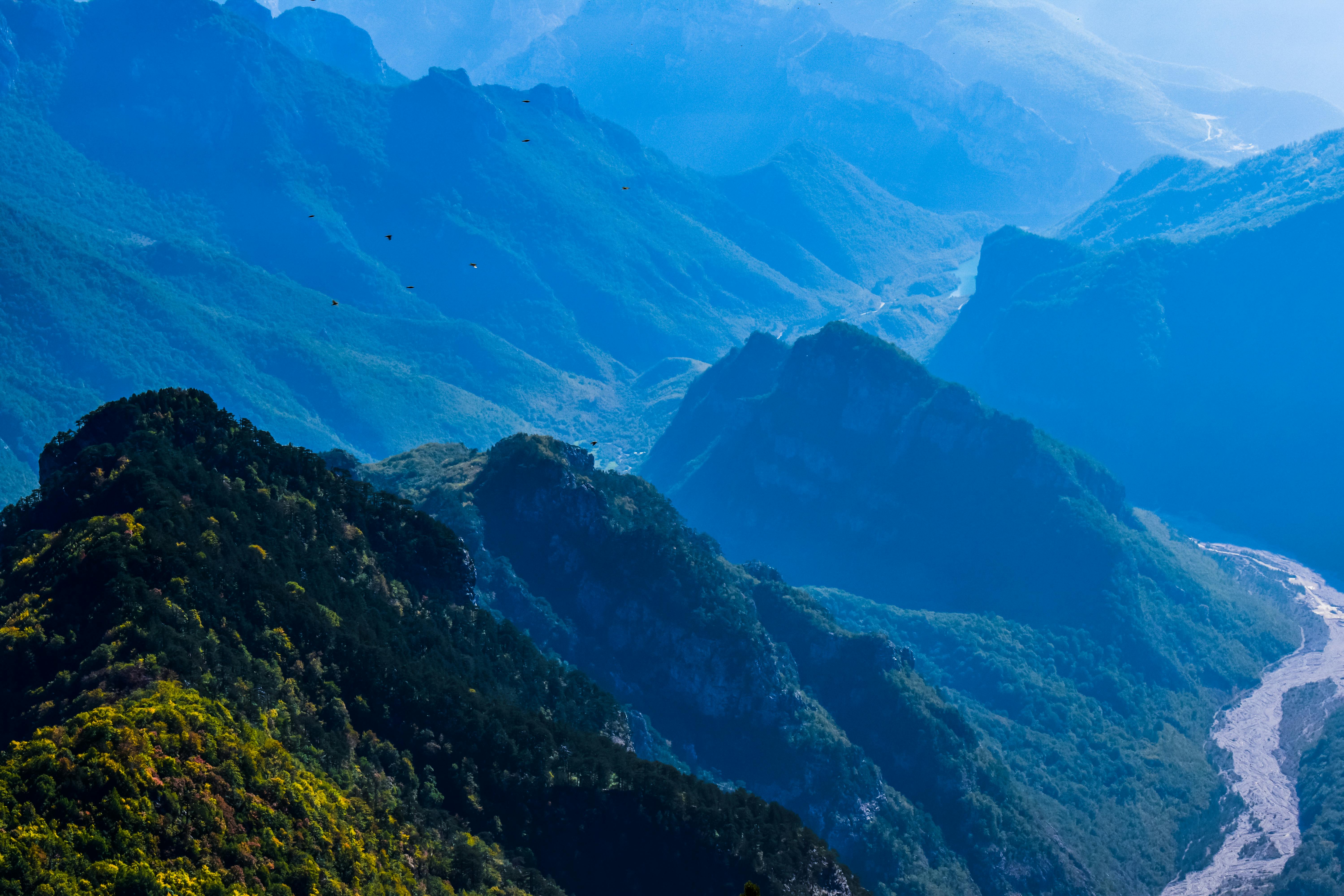 Rock Formation near Mountain Ranges · Free Stock Photo