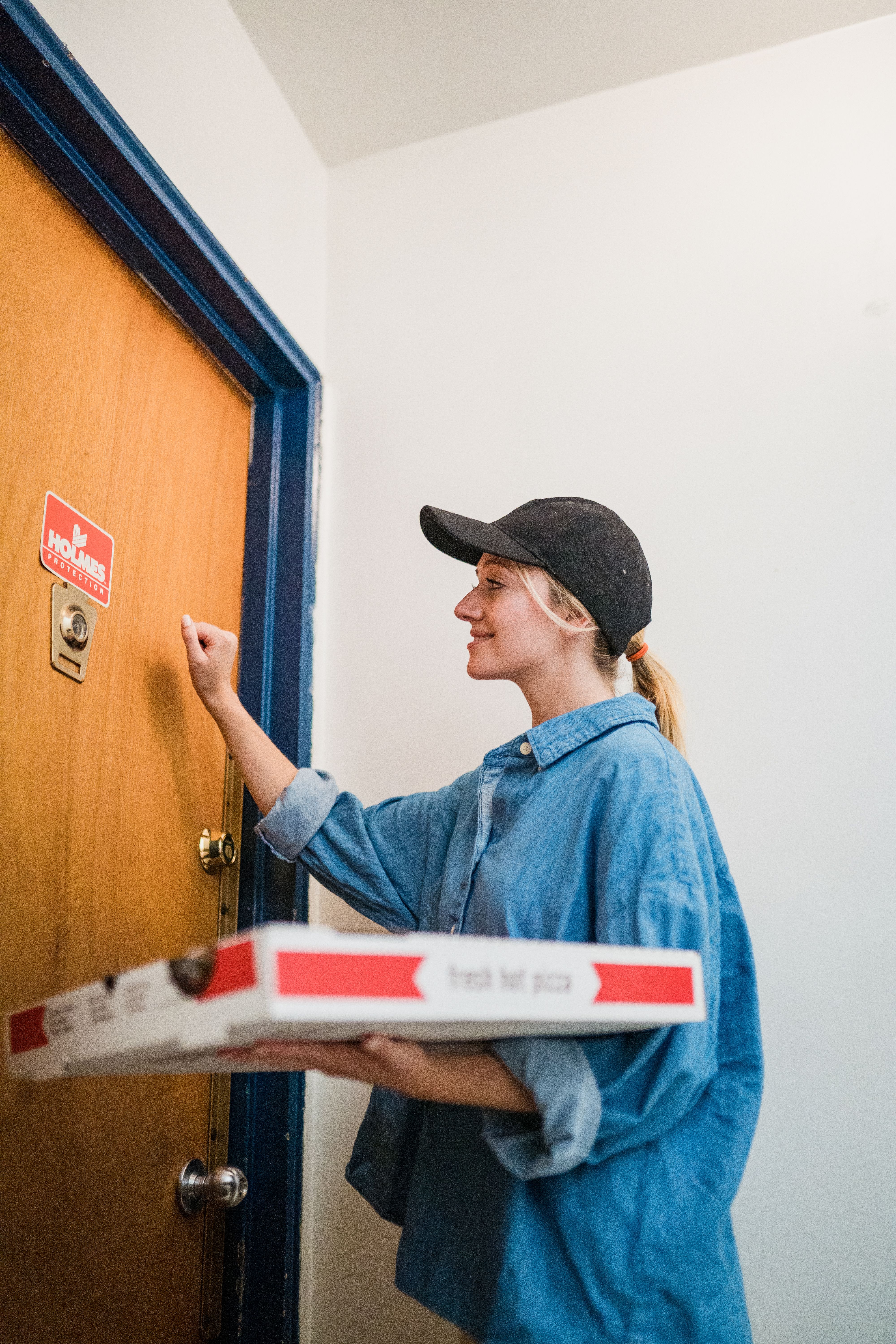 Woman with Pizza at Door · Free Stock Photo