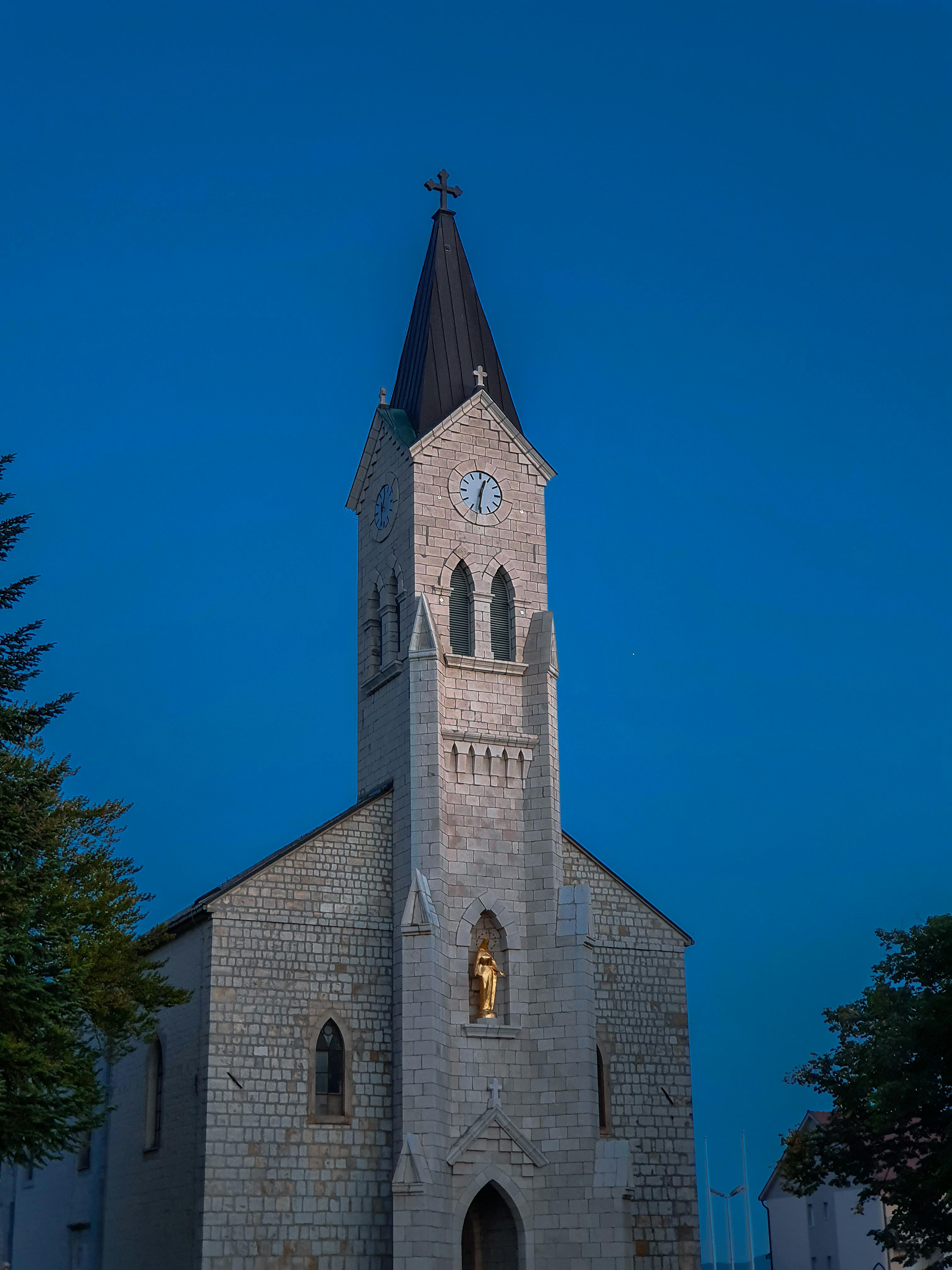 Gray Concrete Building of Church Under Blue Sky · Free Stock Photo