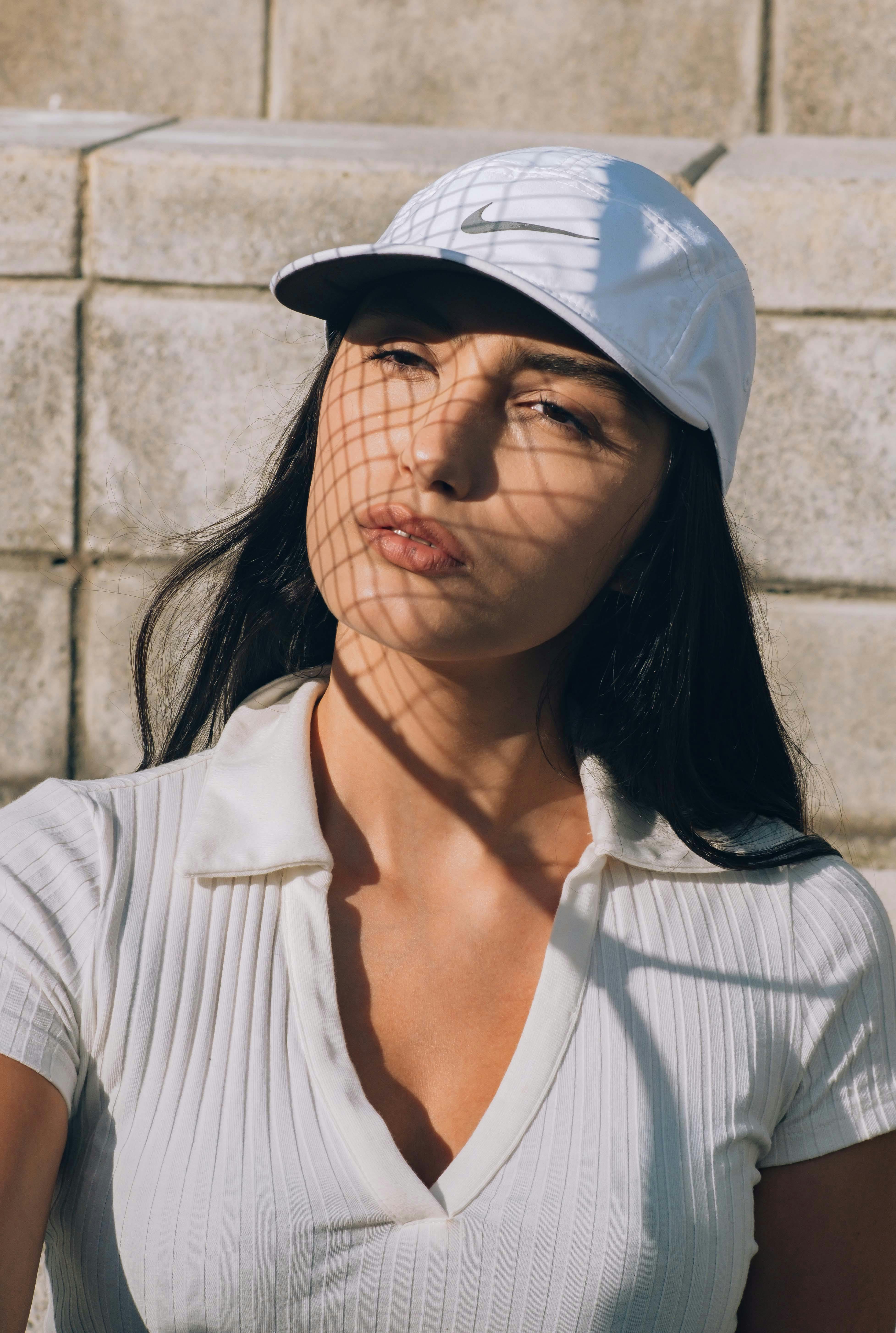 Portrait of a Pretty Woman Wearing White Cap · Free Stock Photo