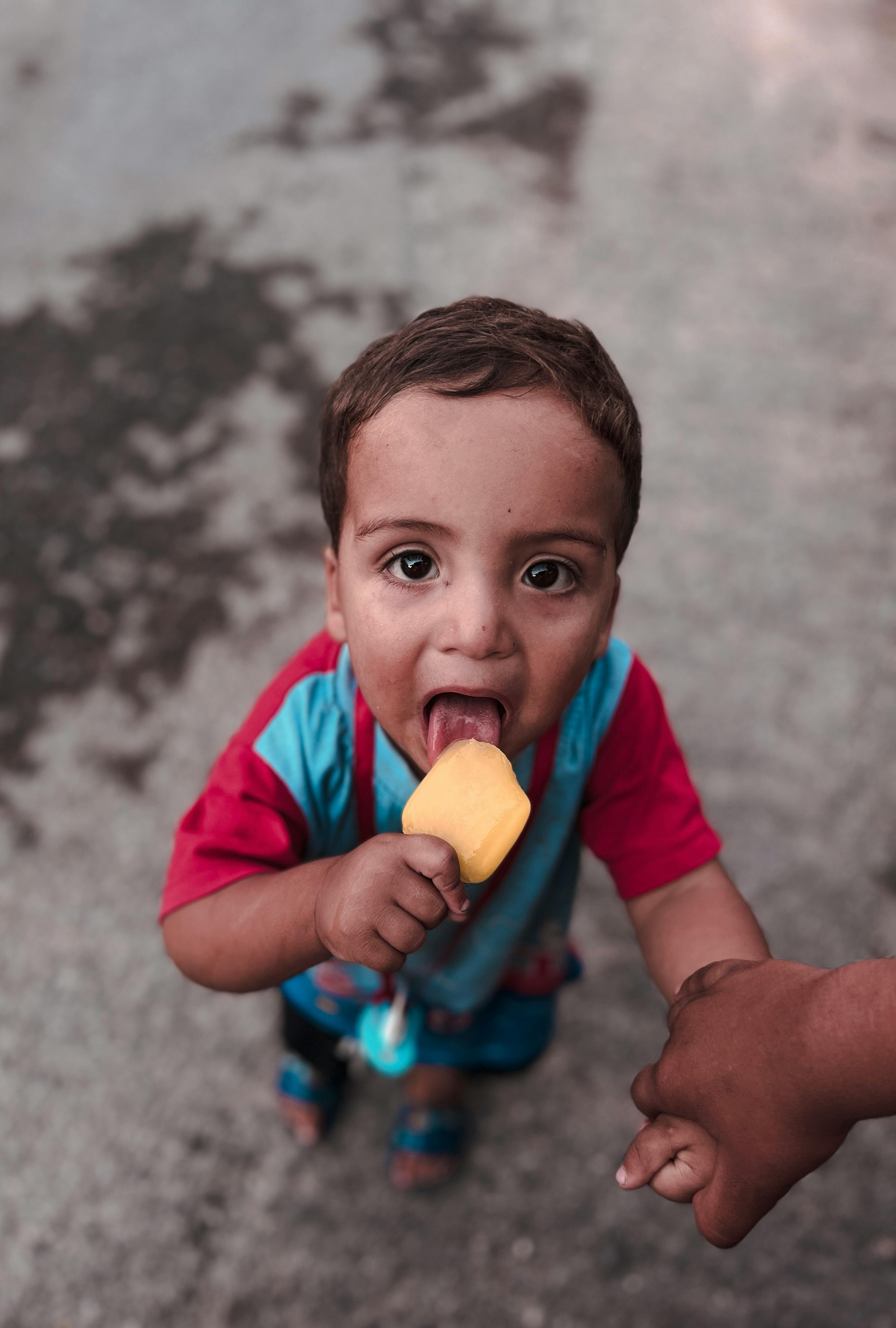 Children Sitting on Wall and Eating Ice Creams · Free Stock Photo