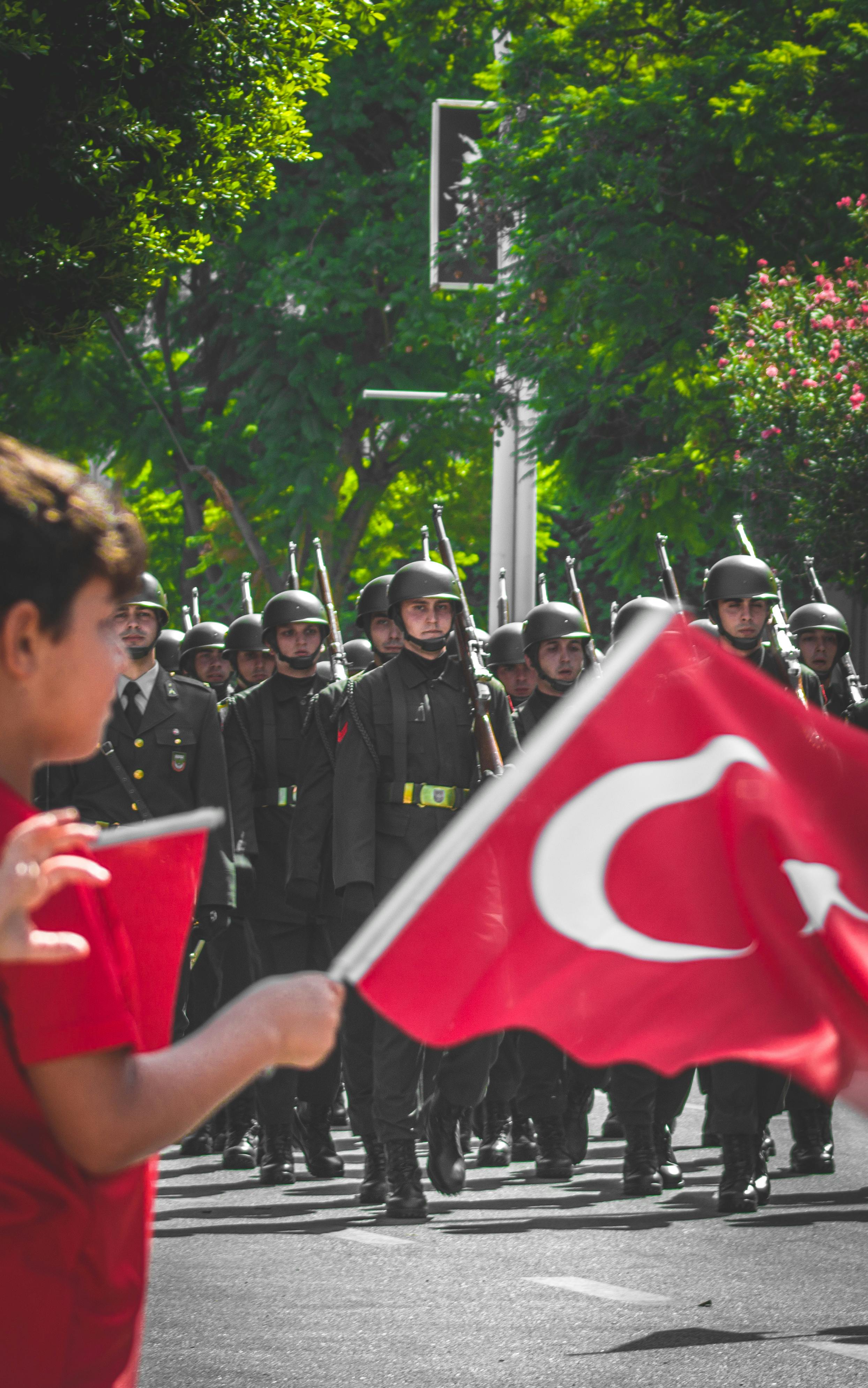 Men in Brown Uniforms Marching on the Road Along a Crowd · Free Stock Photo