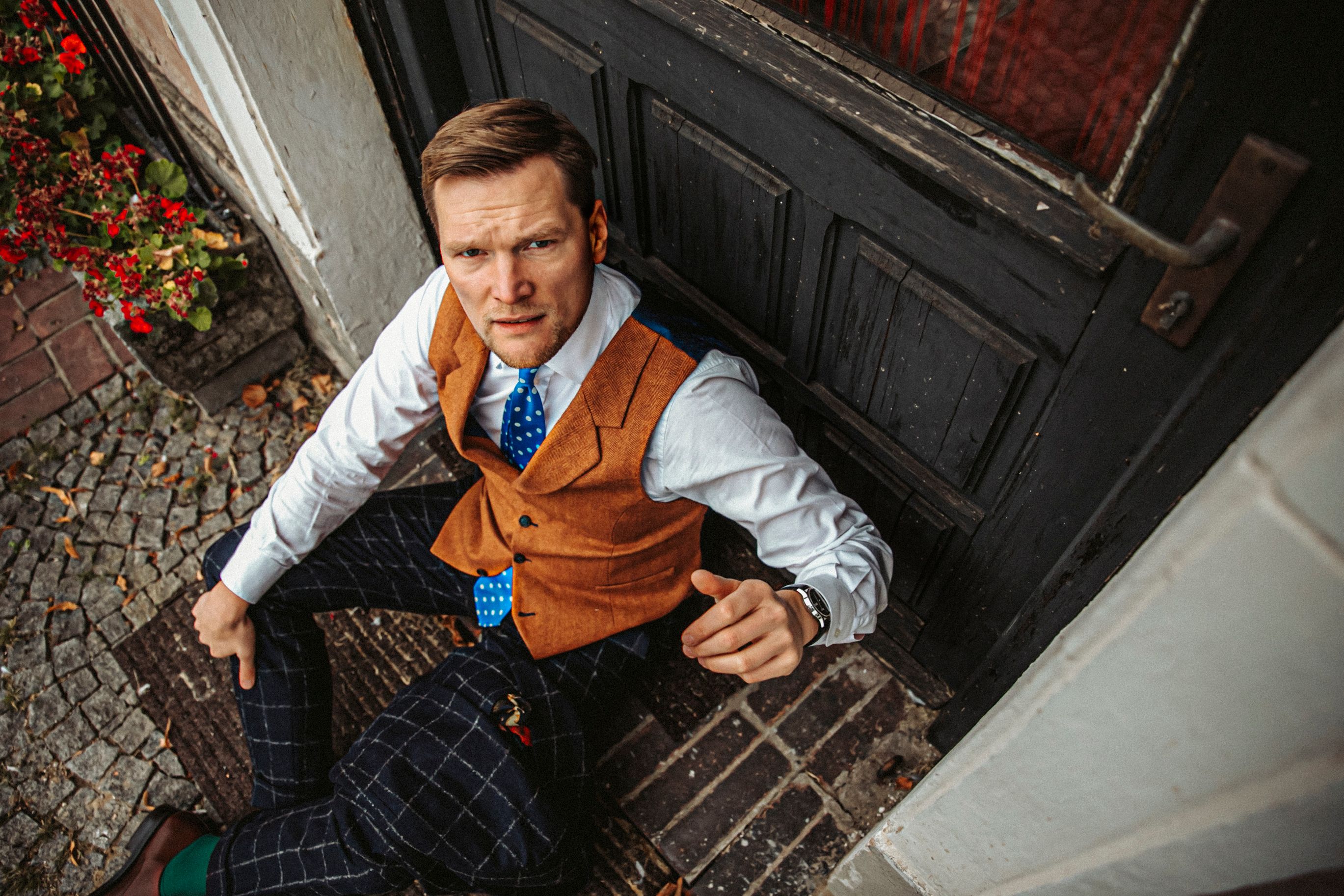 Elegant Man Sitting at Doorstep · Free Stock Photo