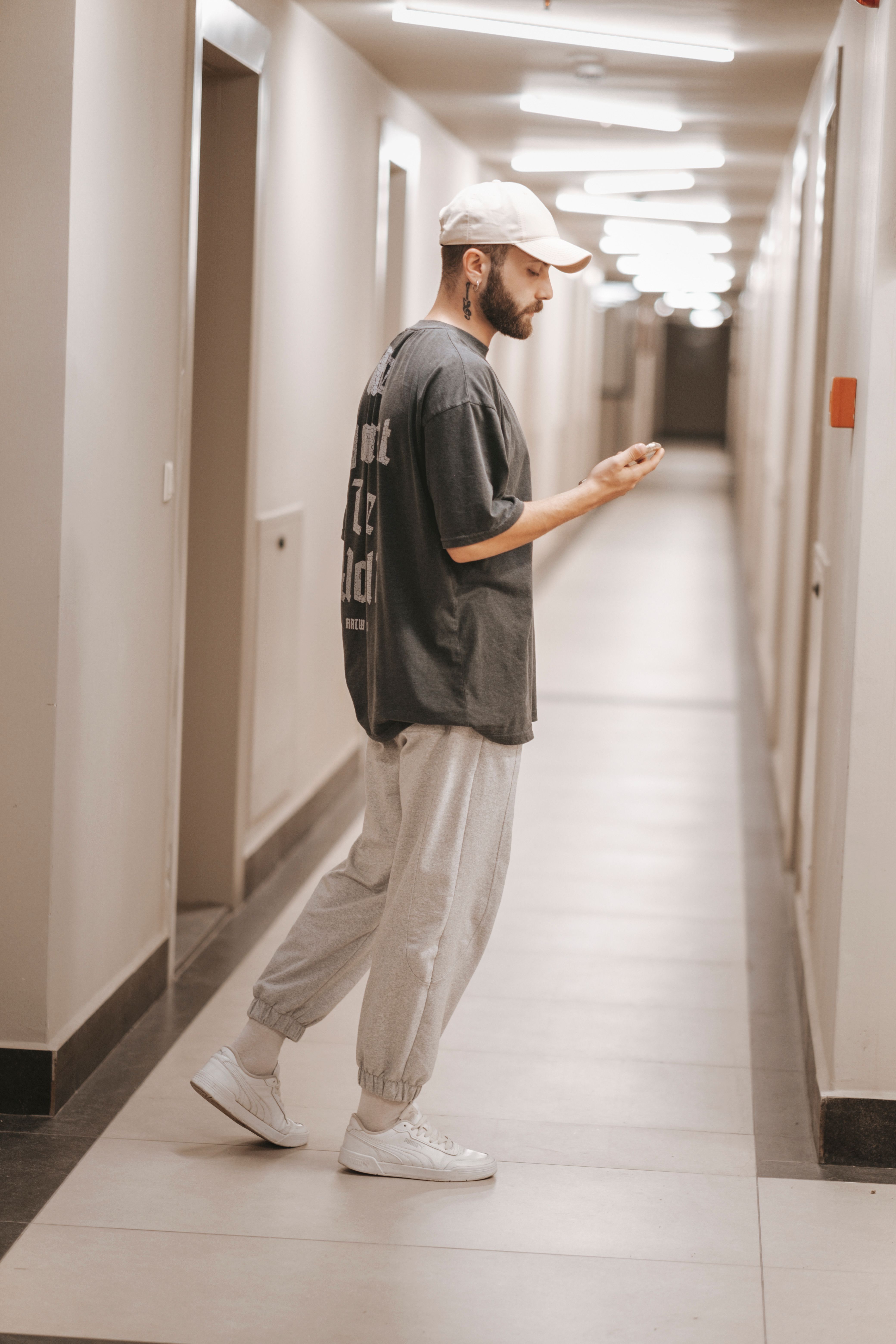 Man Standing in a Corridor · Free Stock Photo