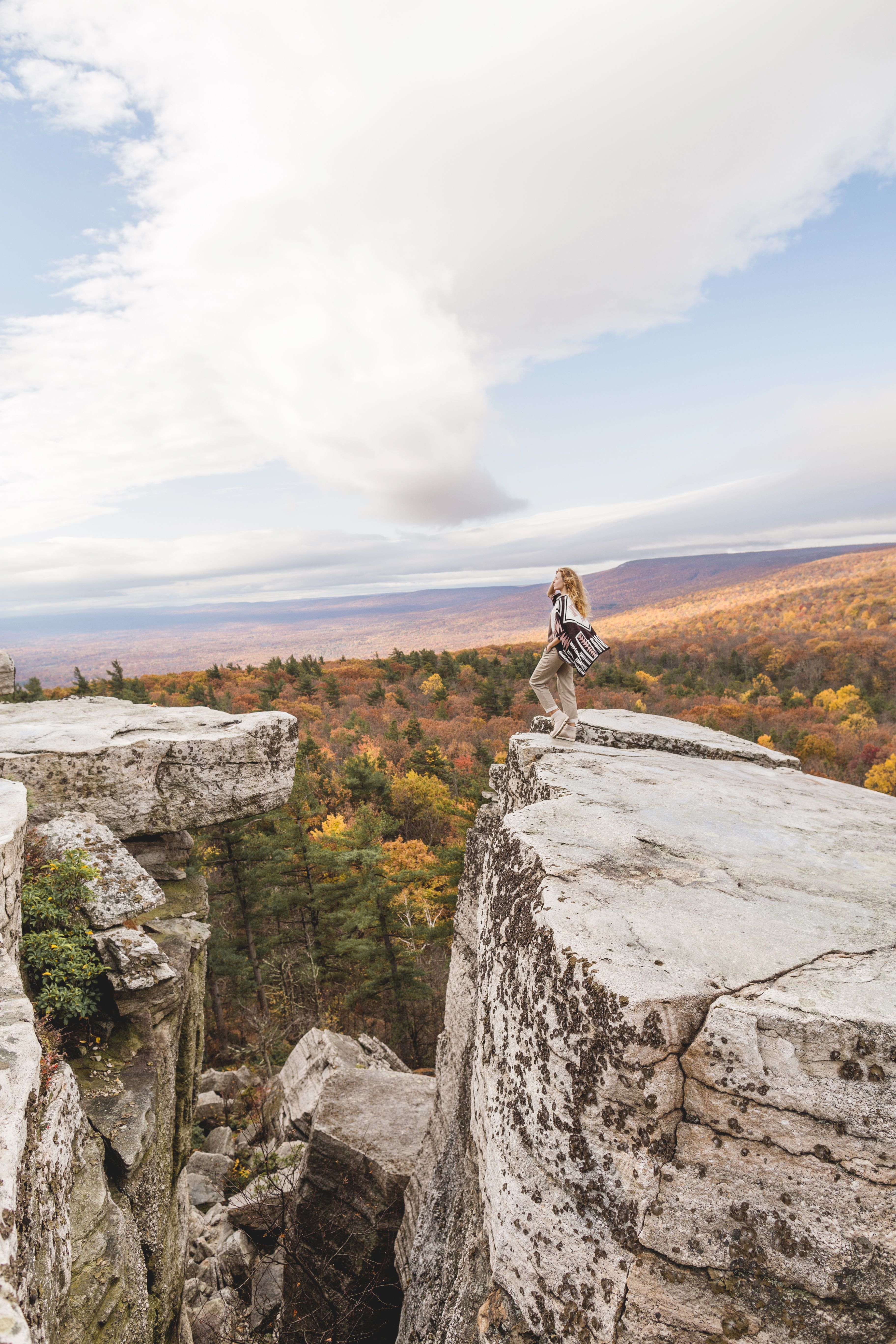 A Woman Standing on Rock Formation · Free Stock Photo