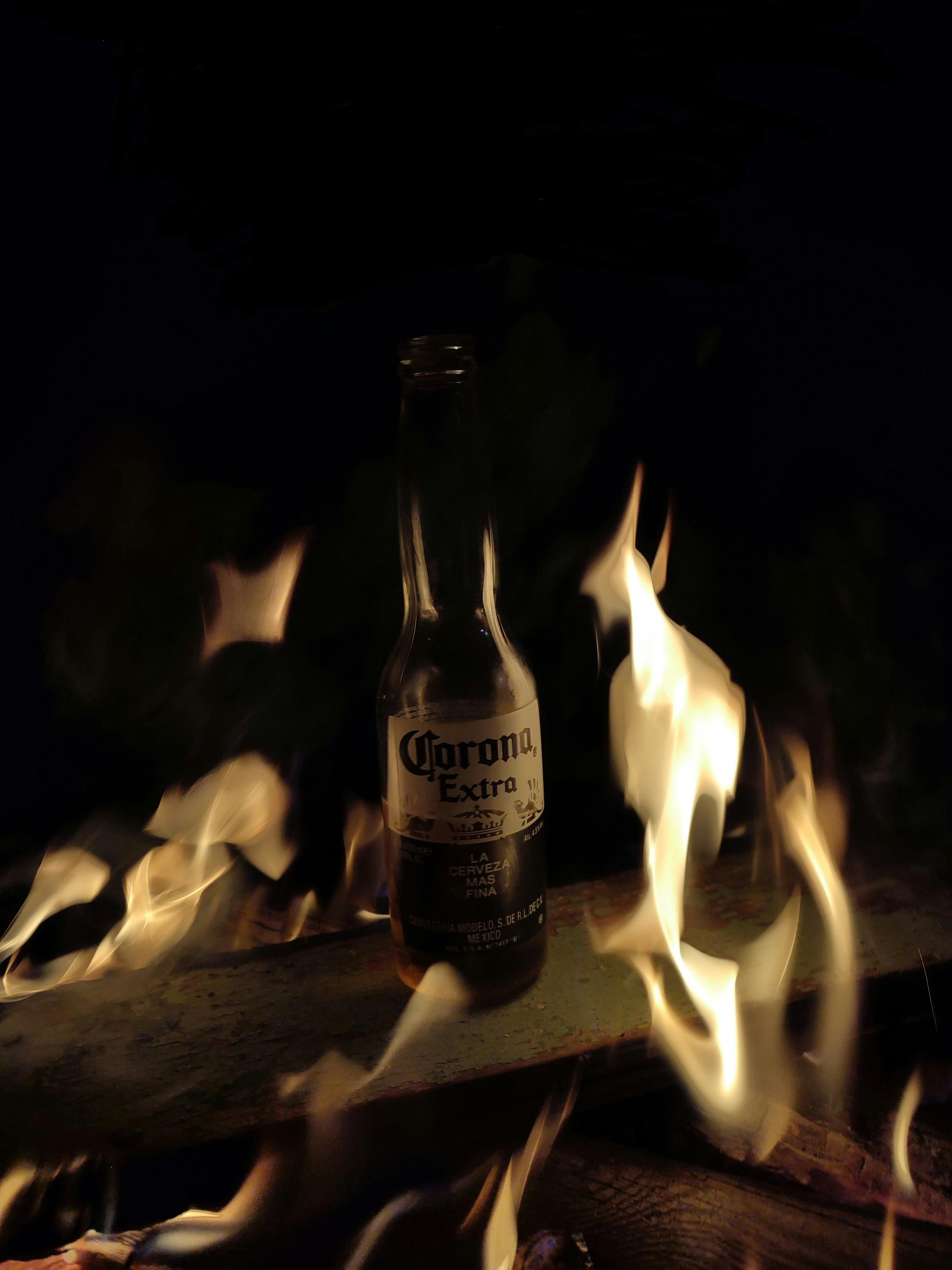 A Bottle of Beer Surrounded by Fire · Free Stock Photo
