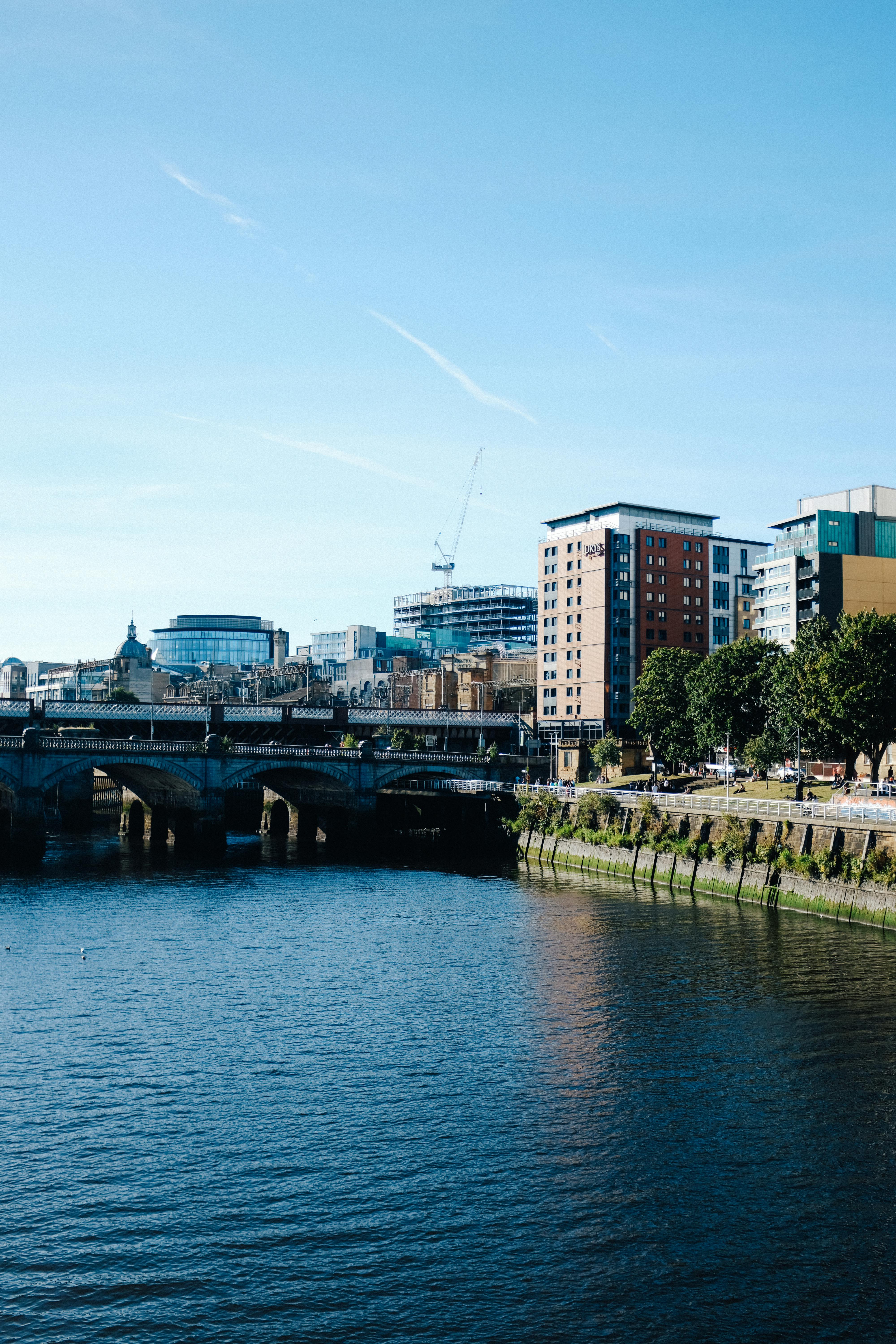 Clear Blue Sky over City Buildings and a Bridge · Free Stock Photo
