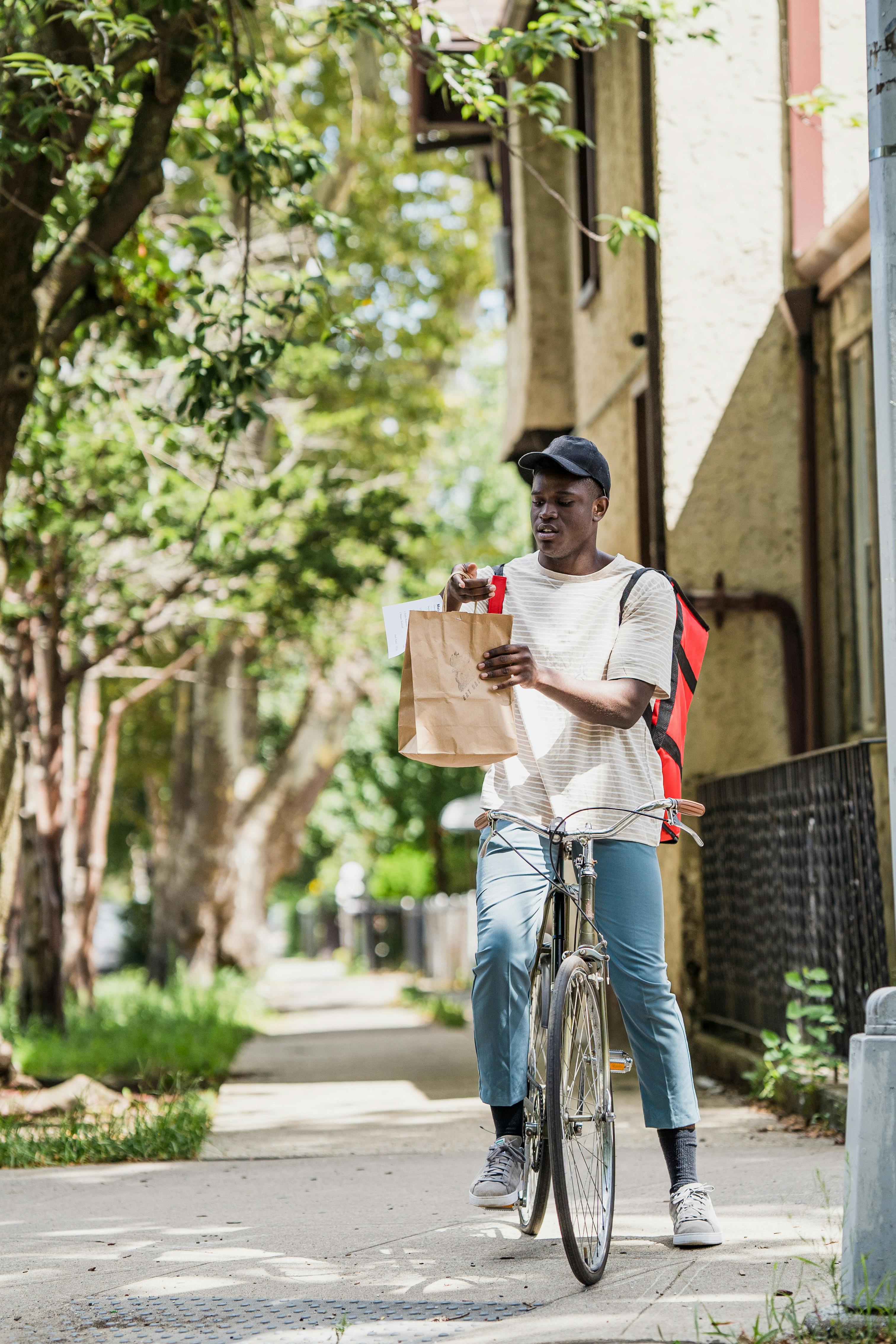 Young Man Working as a Food Delivery Man Carrying a Food Delivery Bag ...