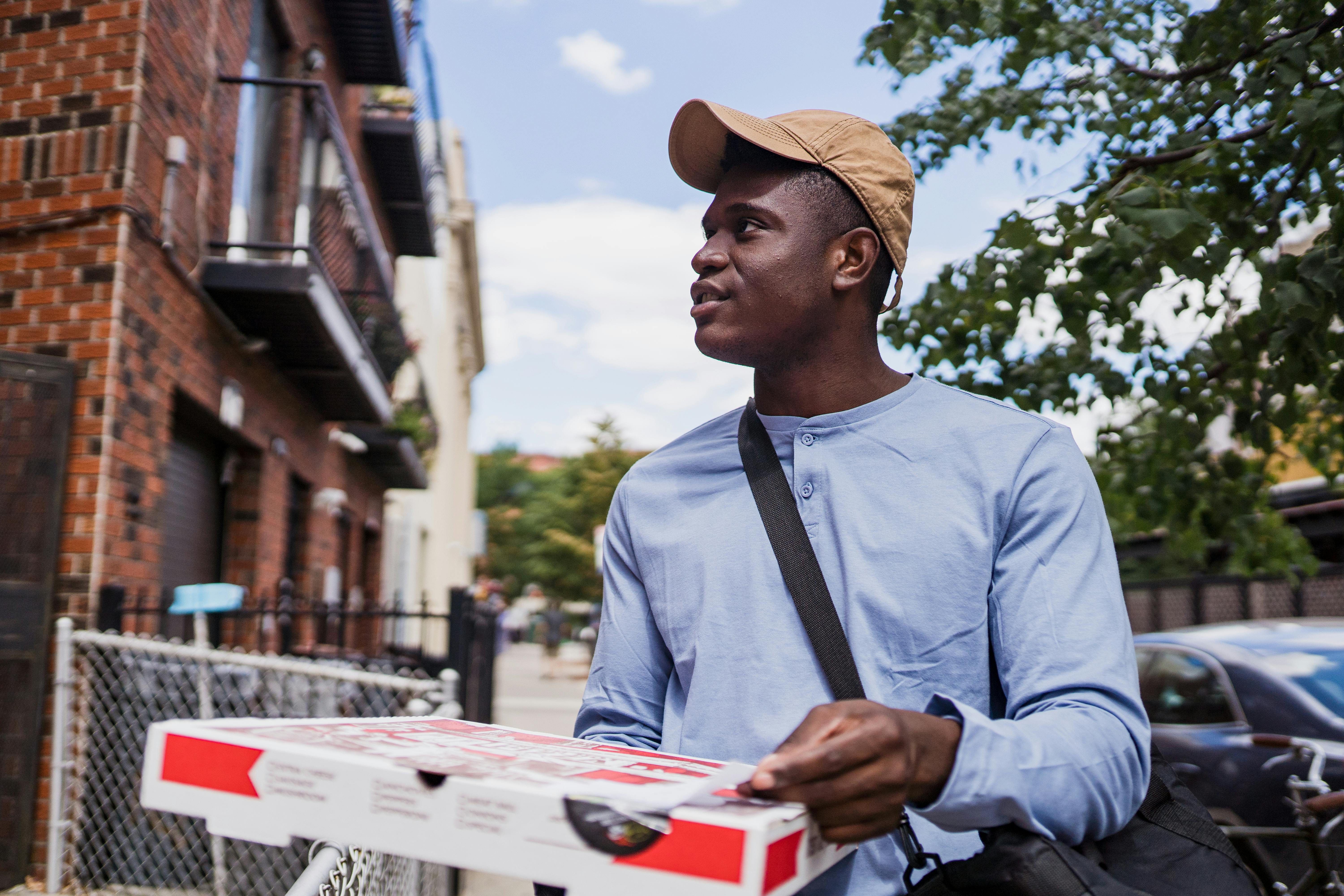 Deliveryman with Pizza Box · Free Stock Photo