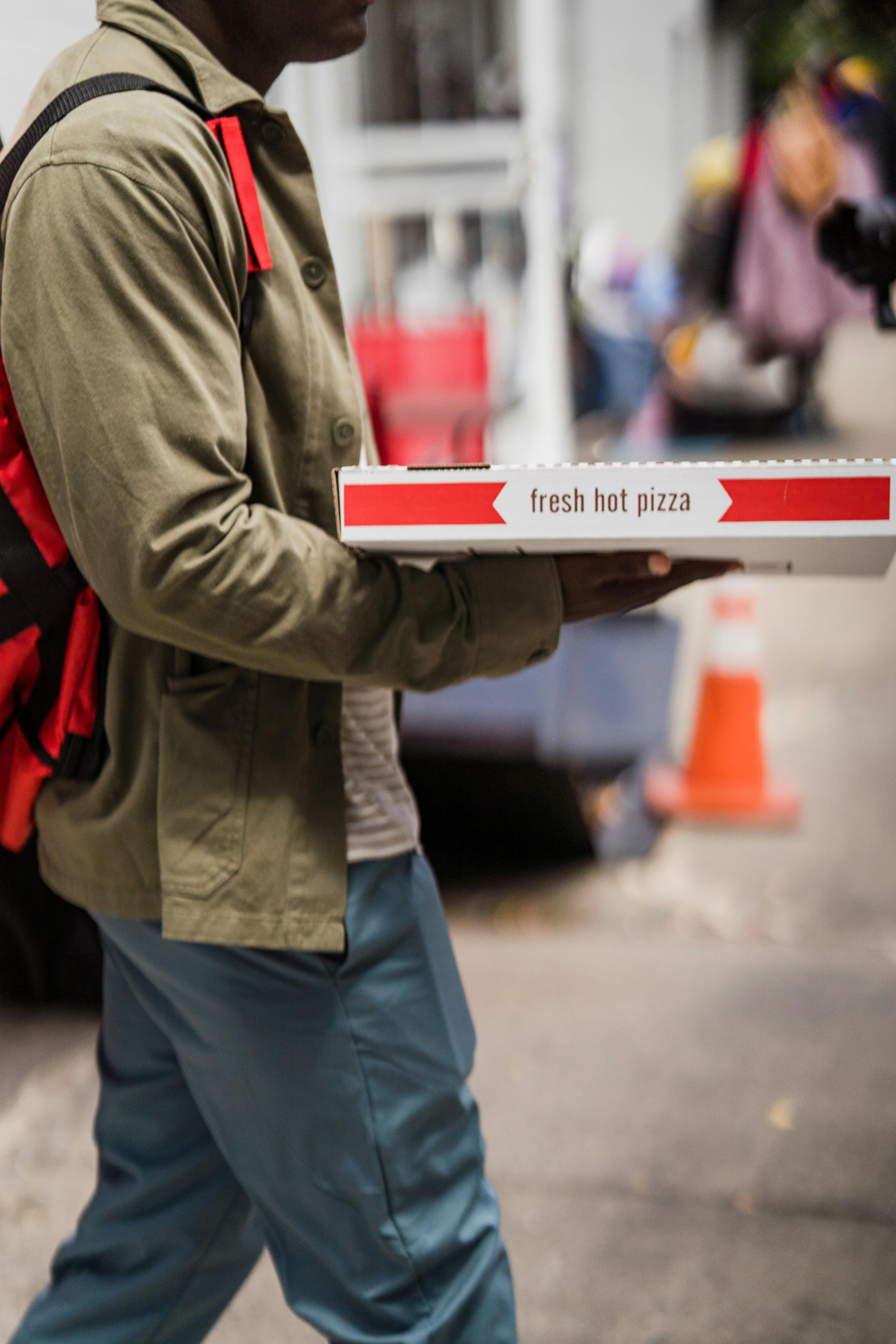 Man Carrying Pizza Box · Free Stock Photo