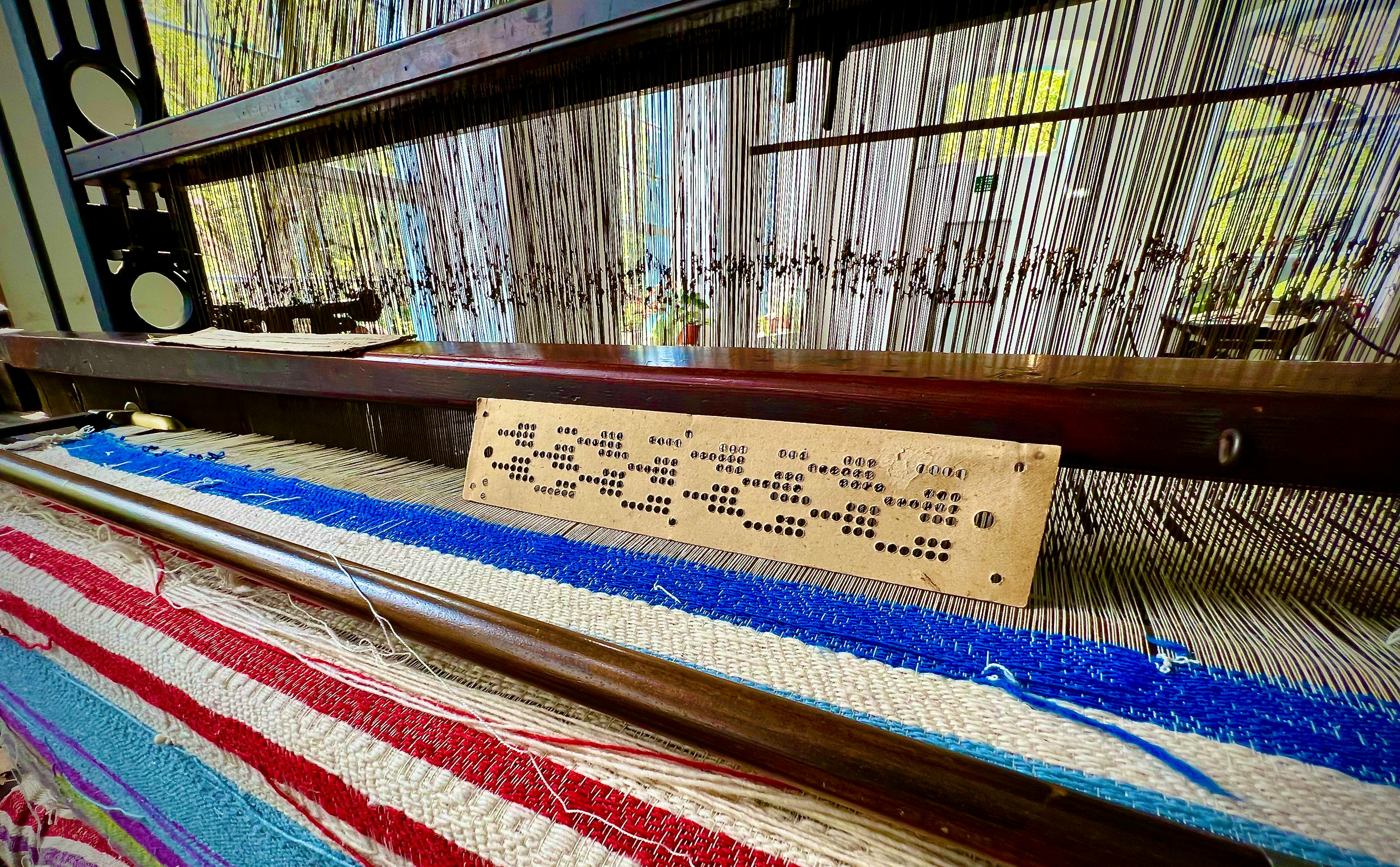 Various colorful threads hanging on rail in workshop · Free Stock Photo