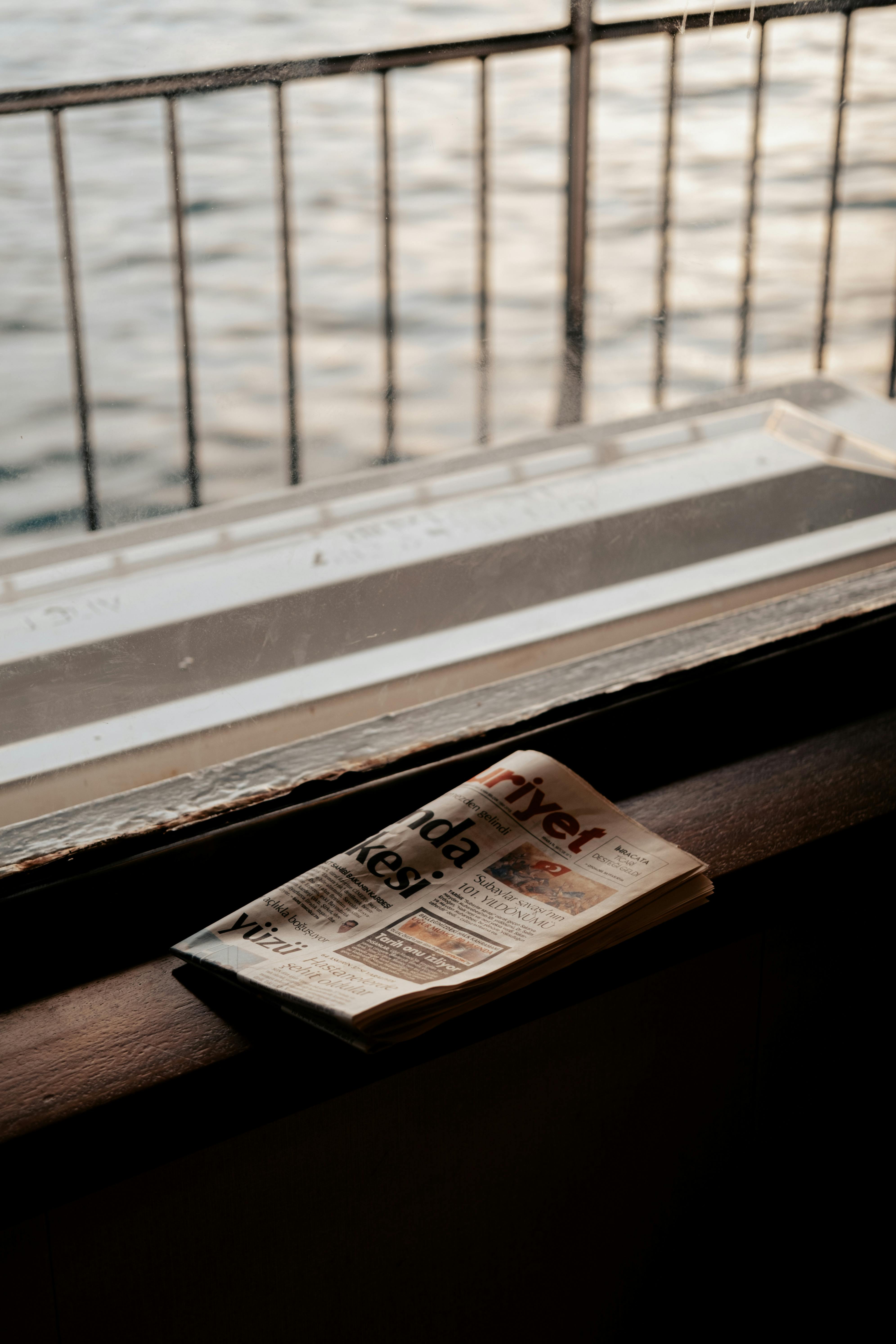 Photo of a Newspaper Near a Window · Free Stock Photo