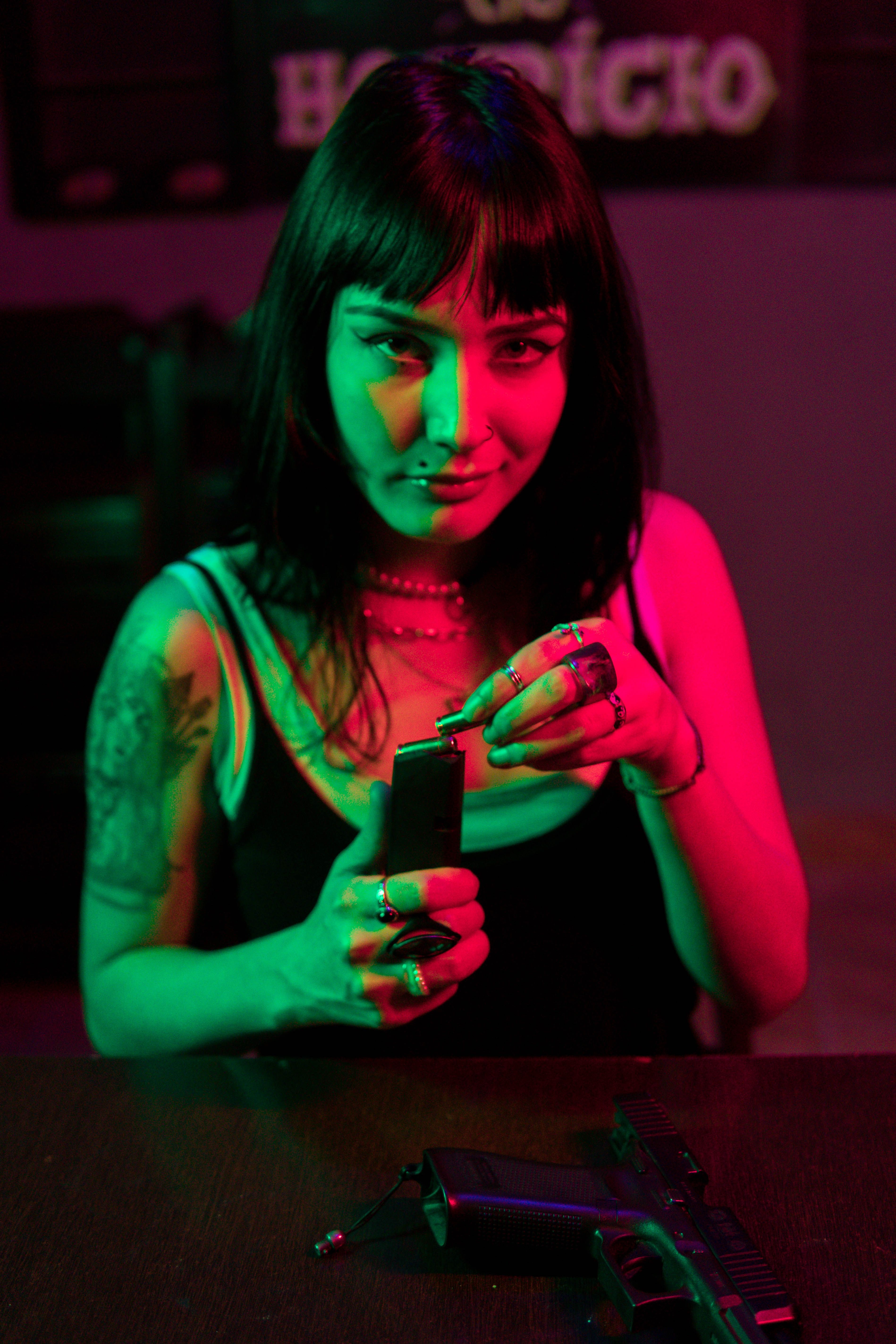 Woman Holding an Ammunition Magazine and Gun · Free Stock Photo