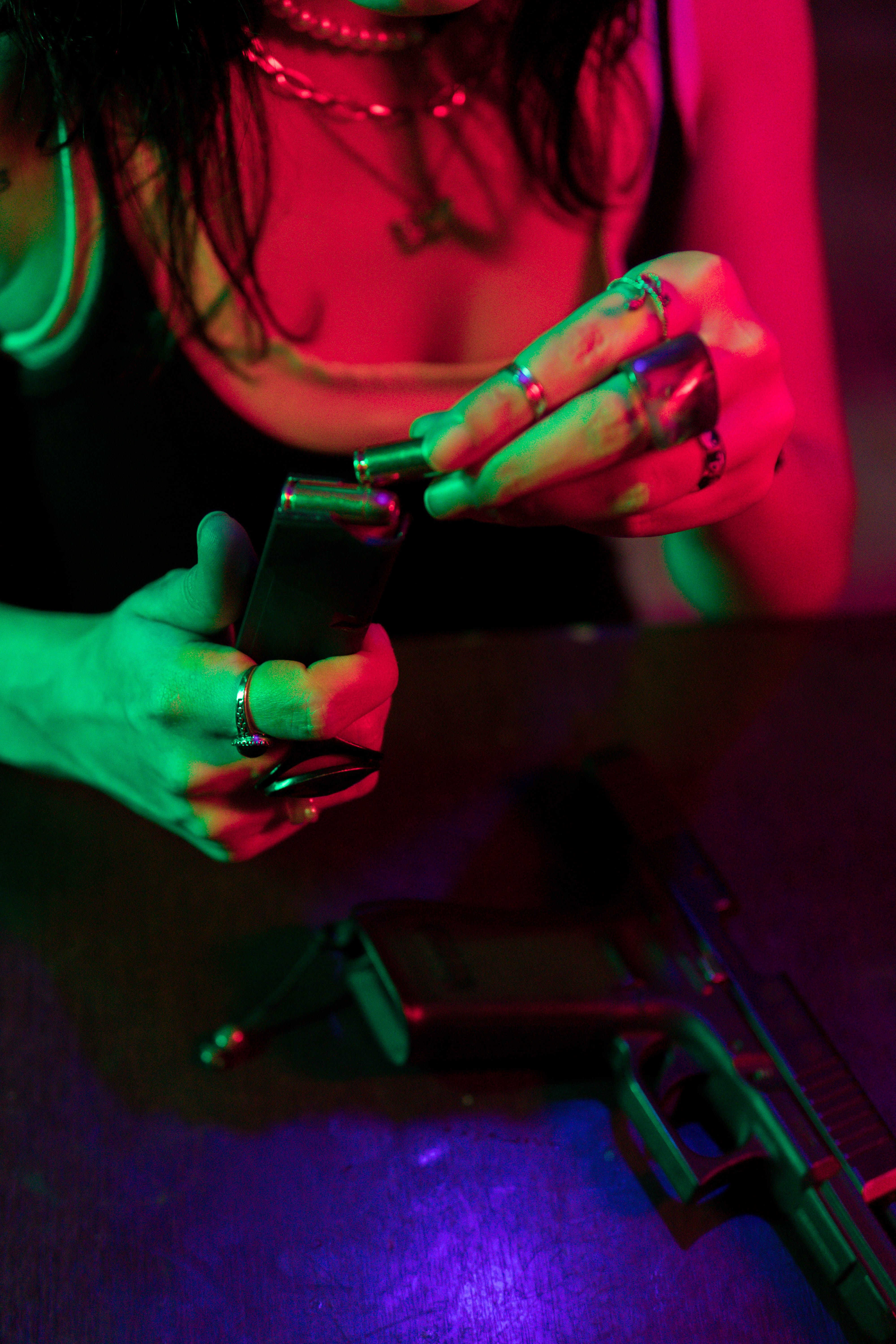 Woman Holding a Bullet · Free Stock Photo
