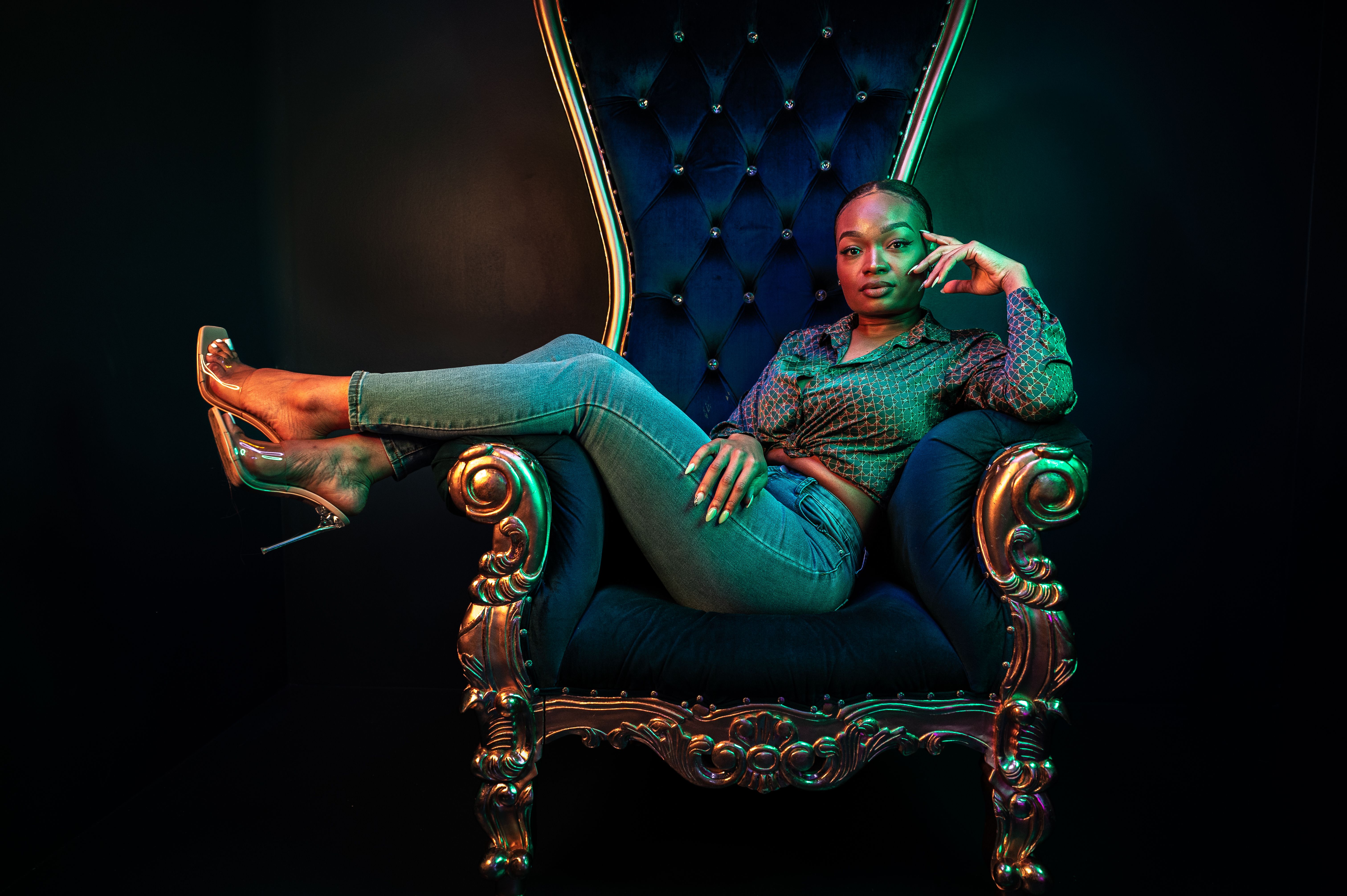 Photo of a Woman Posing on a Blue Armchair · Free Stock Photo