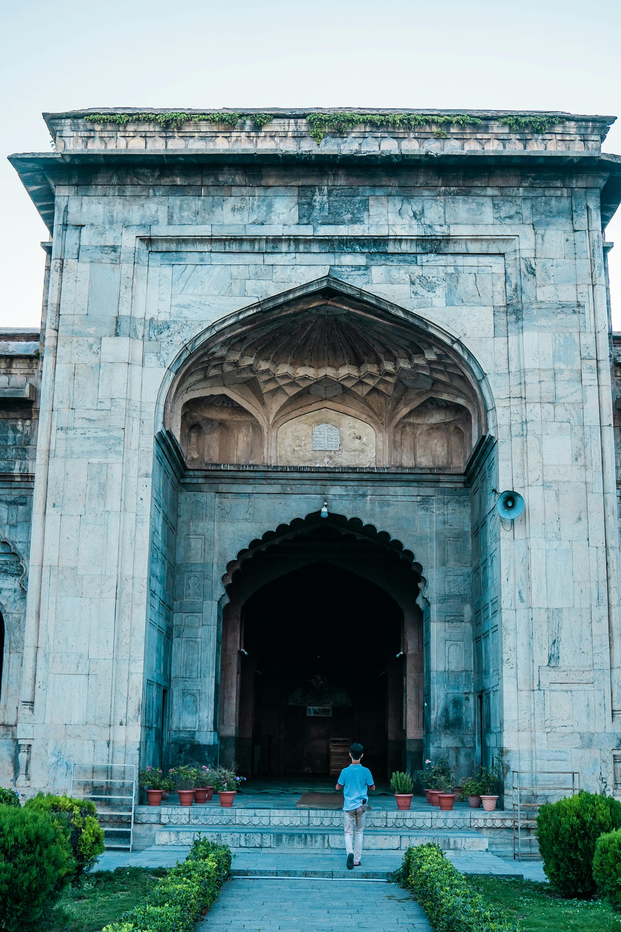 Person Sweeping Temple Entrance · Free Stock Photo