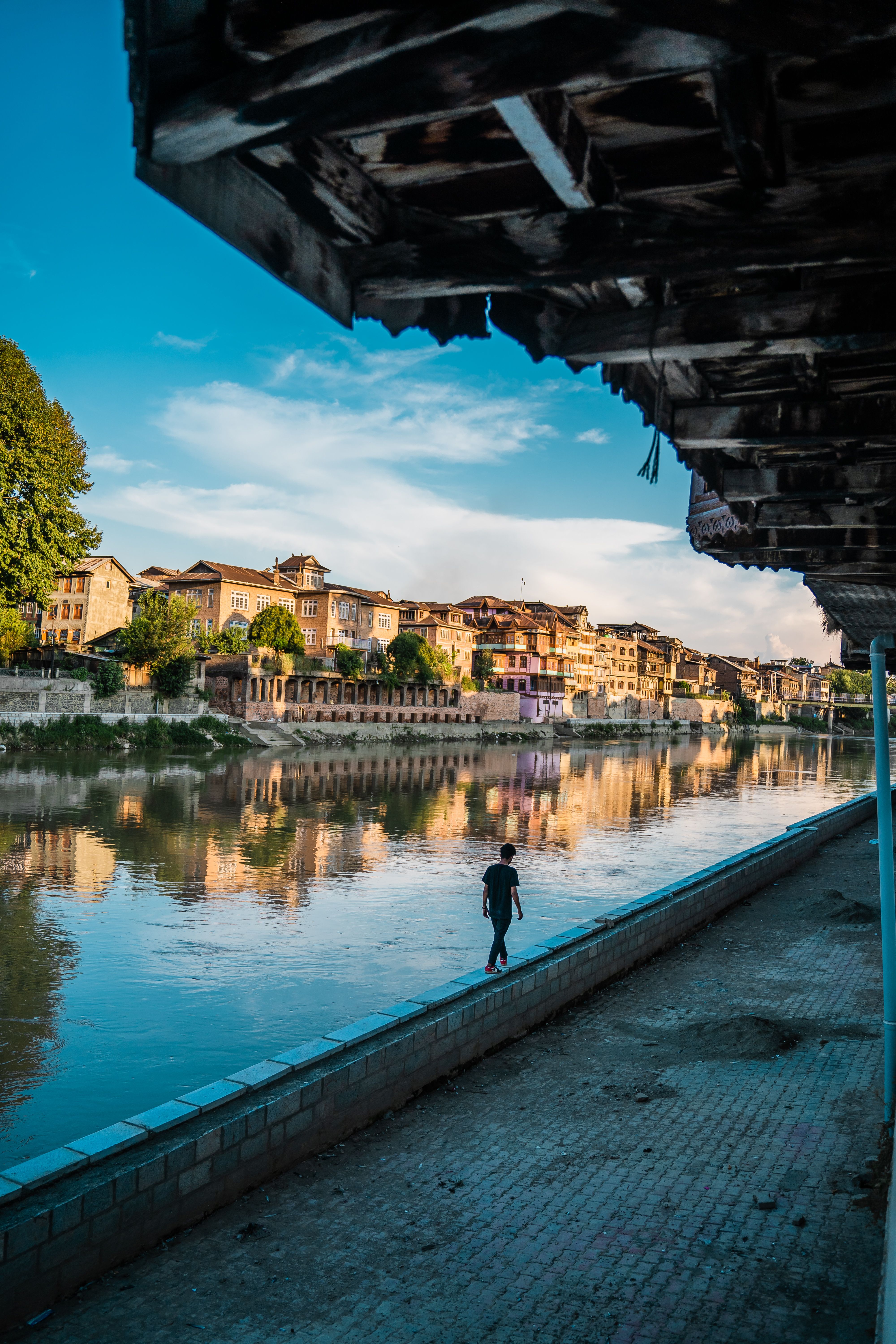 Man Walking on a Concrete Barrier · Free Stock Photo