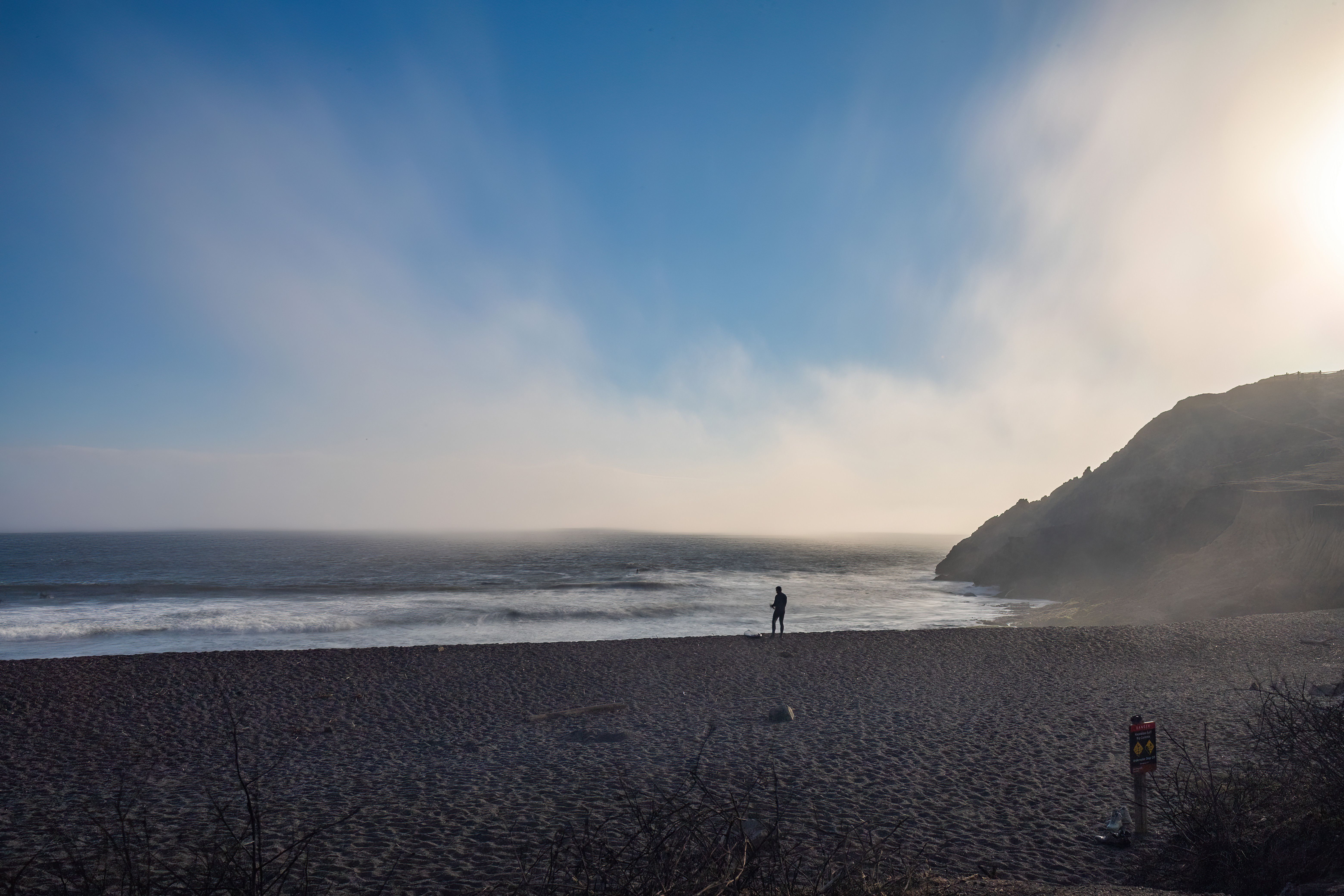 Silhouette of Person Standing on Seaside · Free Stock Photo