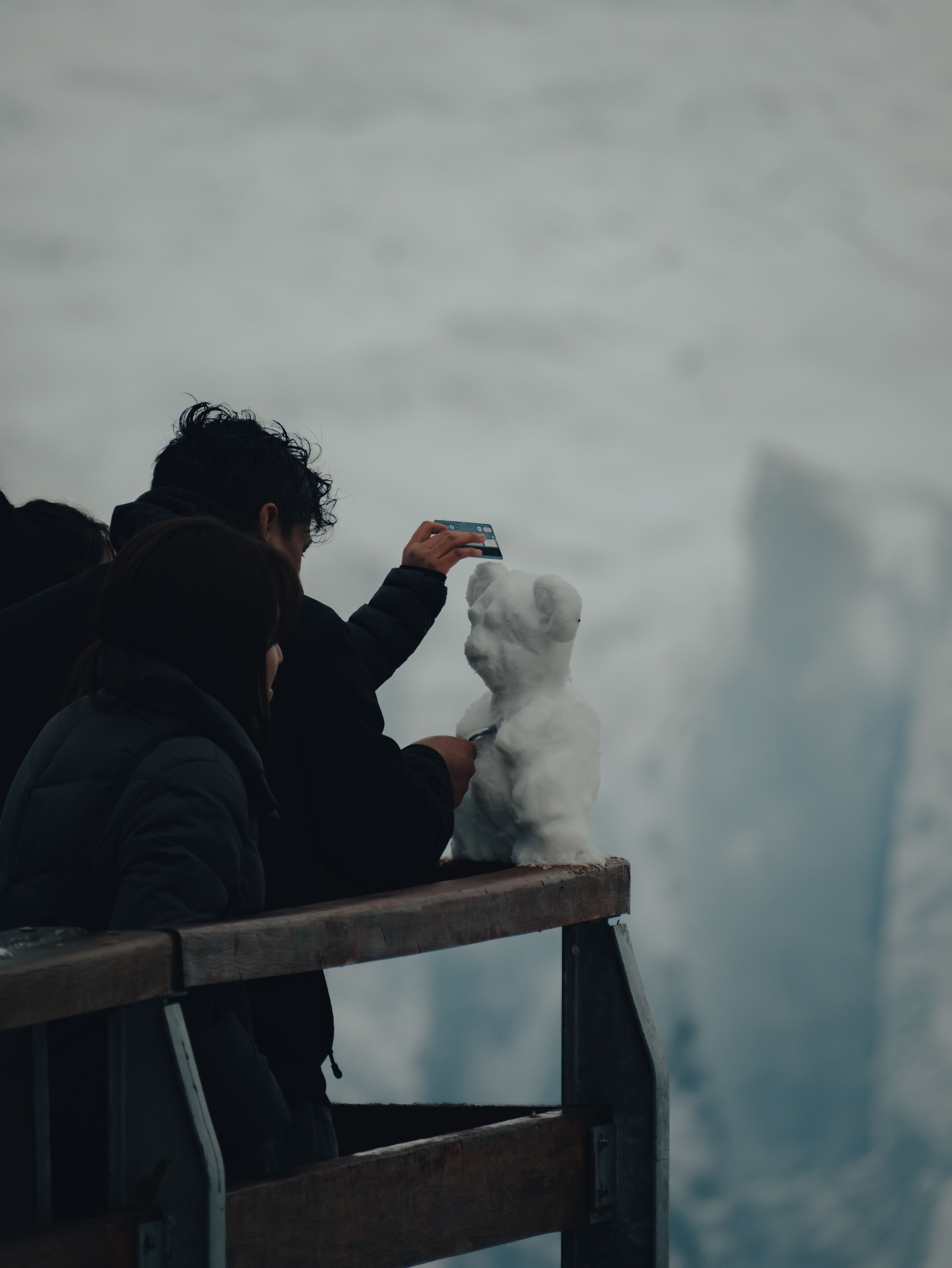 Man Forming a Teddy Bear in Ice using his Credit Card · Free Stock Photo