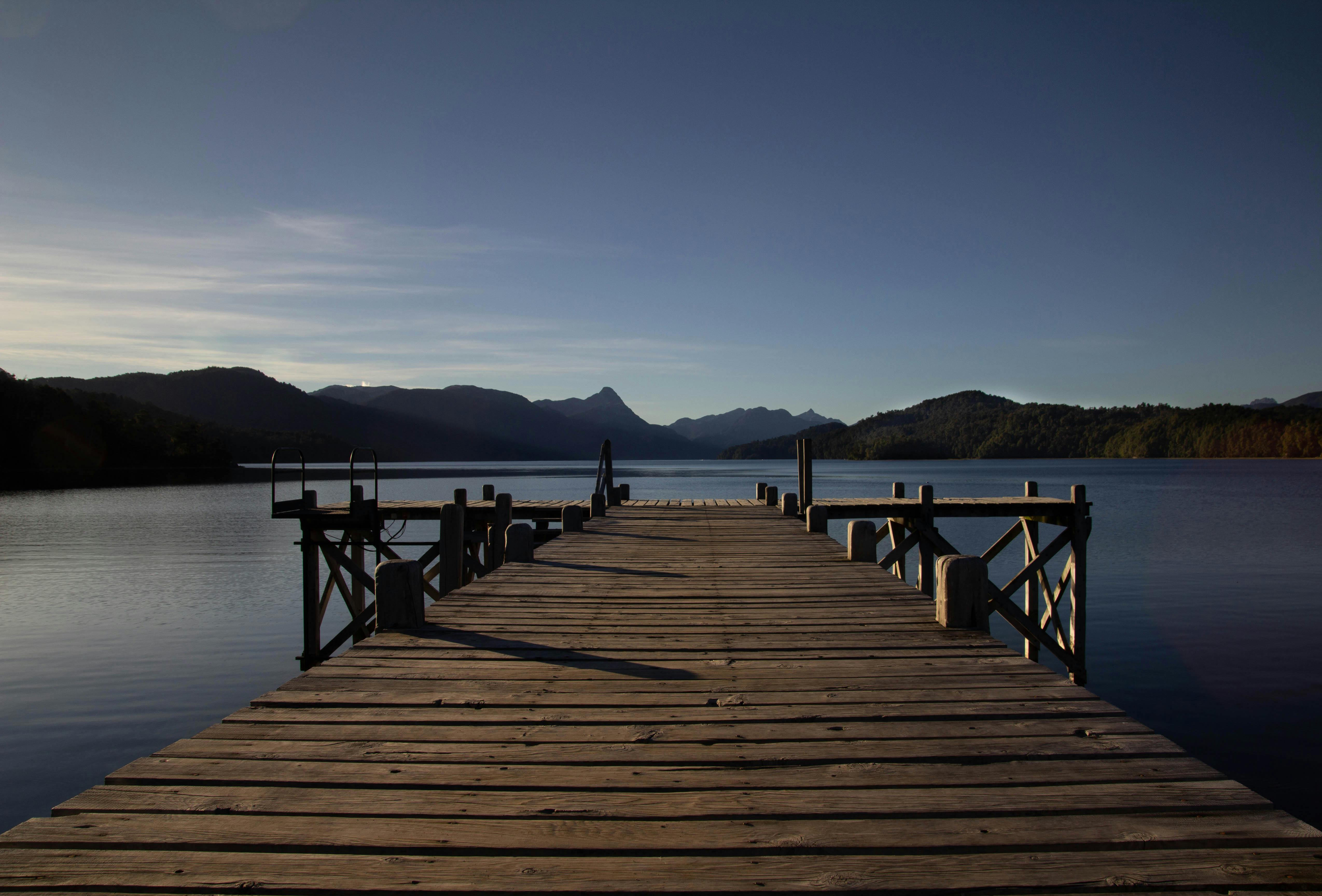 Boat Beside Dock during Golden Hour · Free Stock Photo
