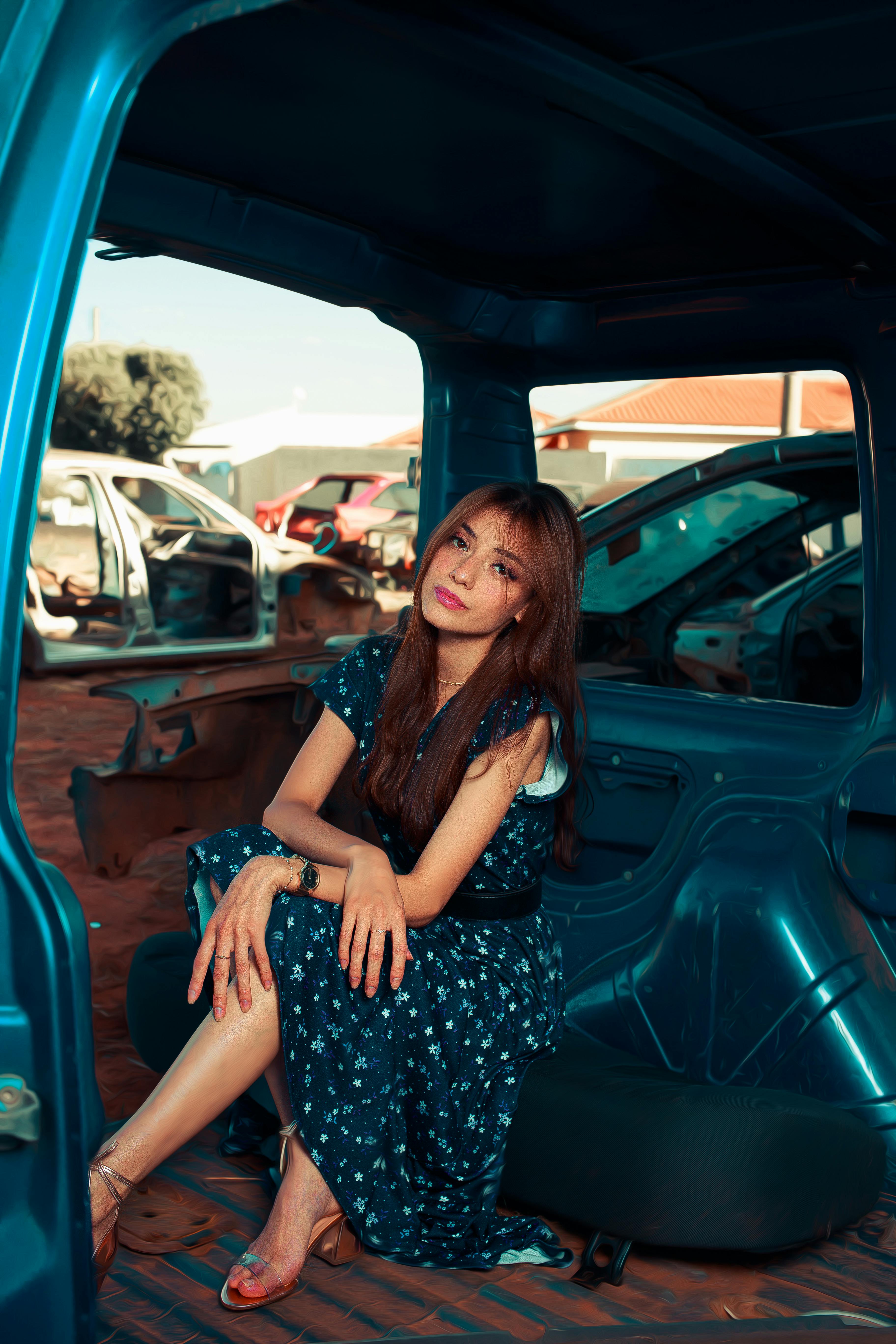 Beautiful Woman Sitting in a Van · Free Stock Photo