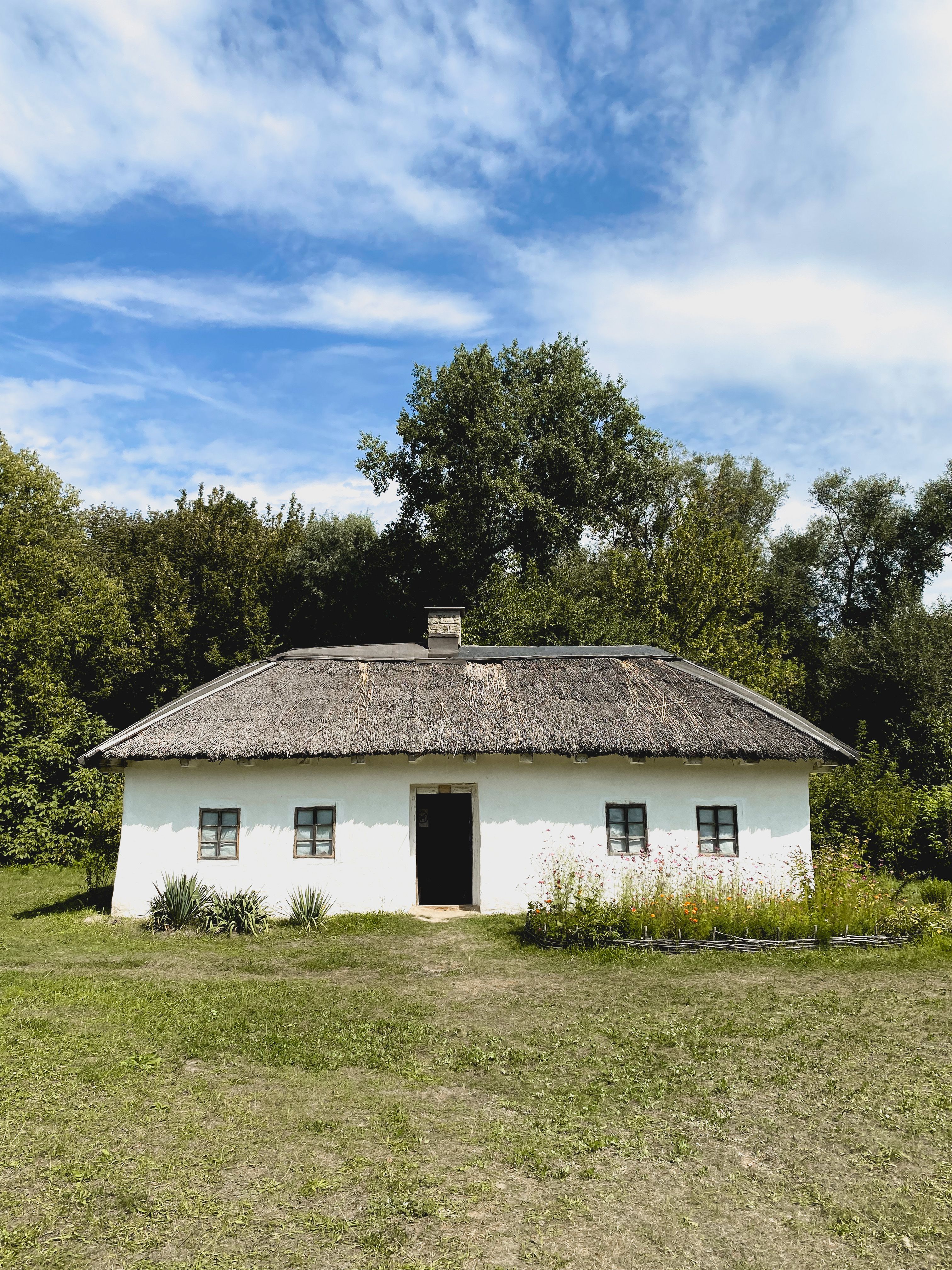 Facade of a House Beside Green Trees · Free Stock Photo