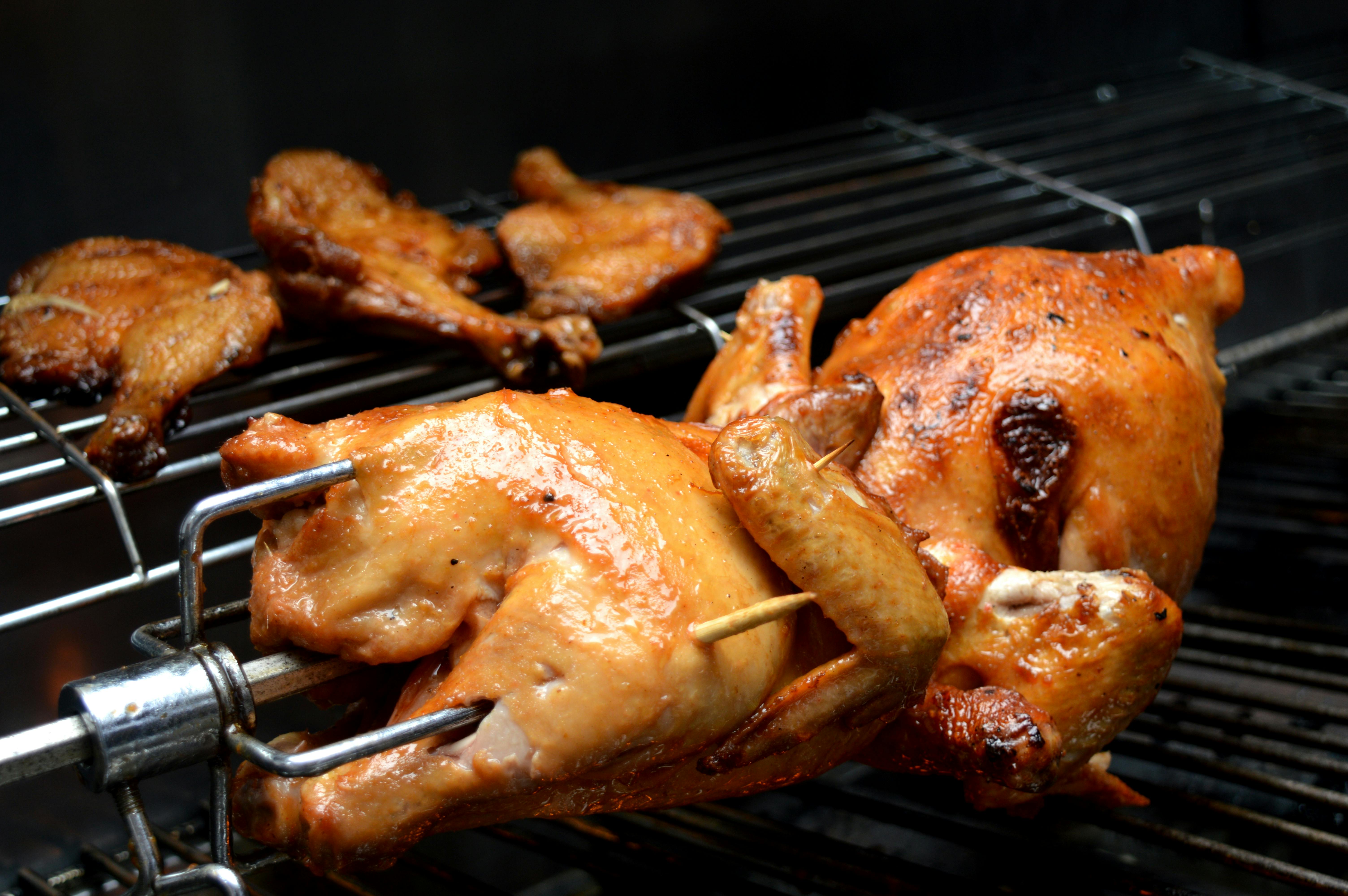 Close Up Shot of Roasted Chickens in the Rotisserie · Free Stock Photo