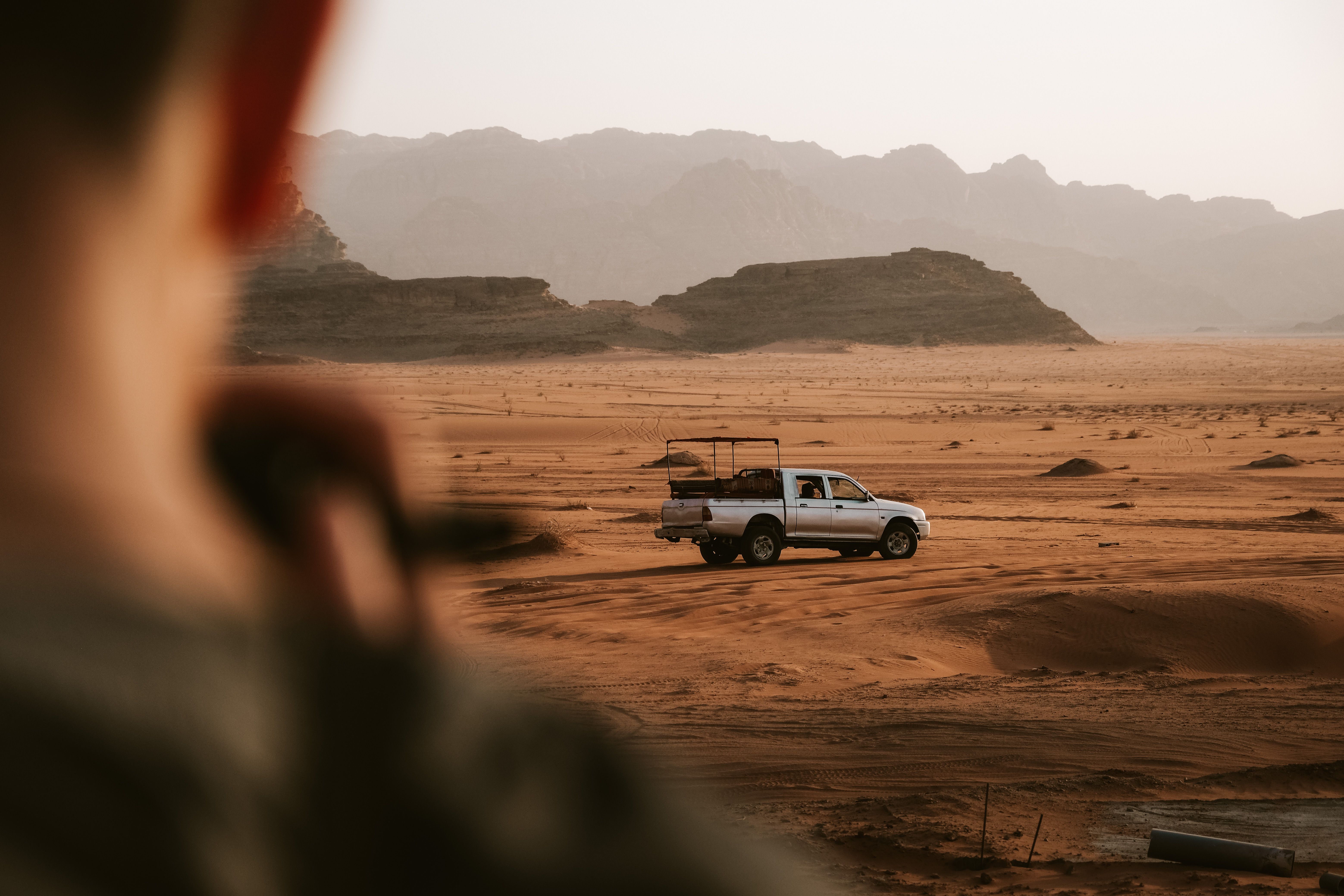 Man Sitting on a Rock in the Wadi Rum Valley in Jordan · Free Stock Photo