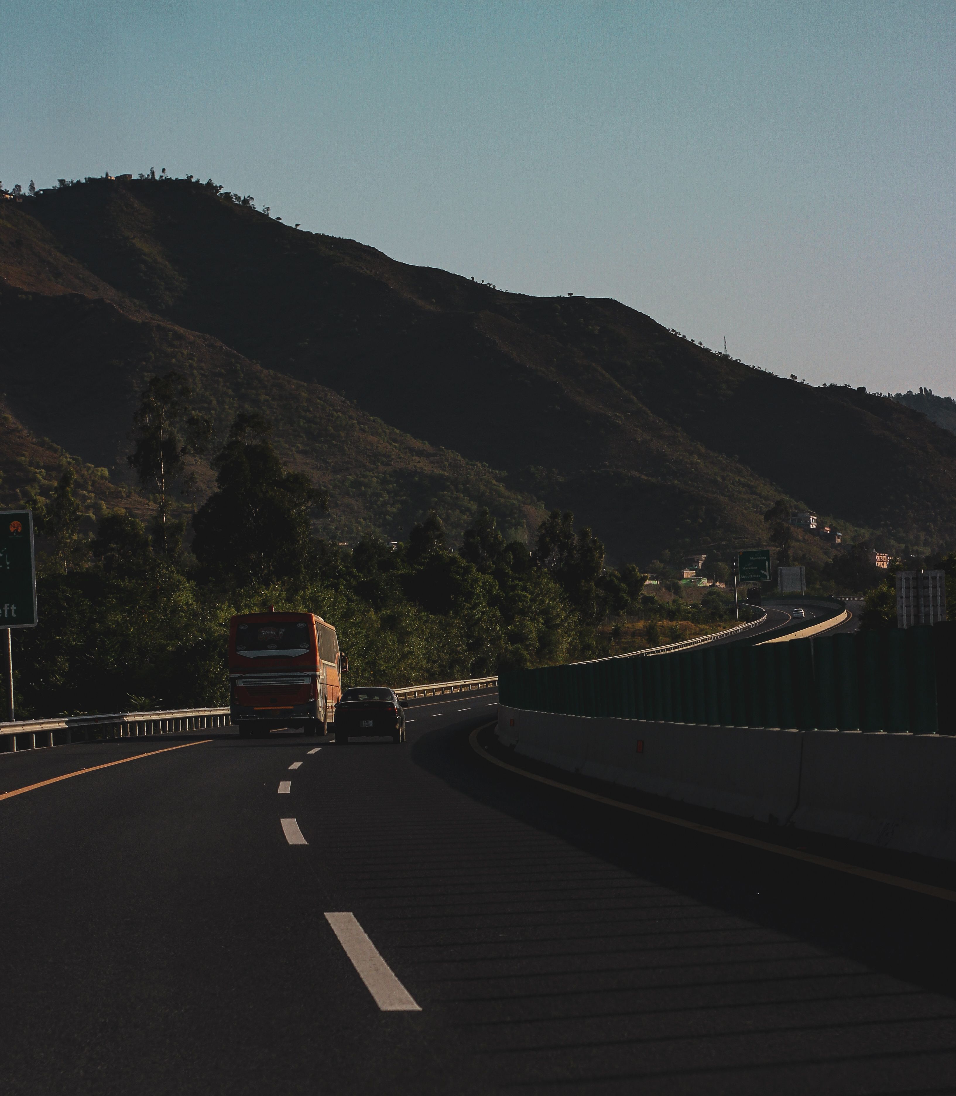 A Car and a Bus on the Road Near Mountain · Free Stock Photo