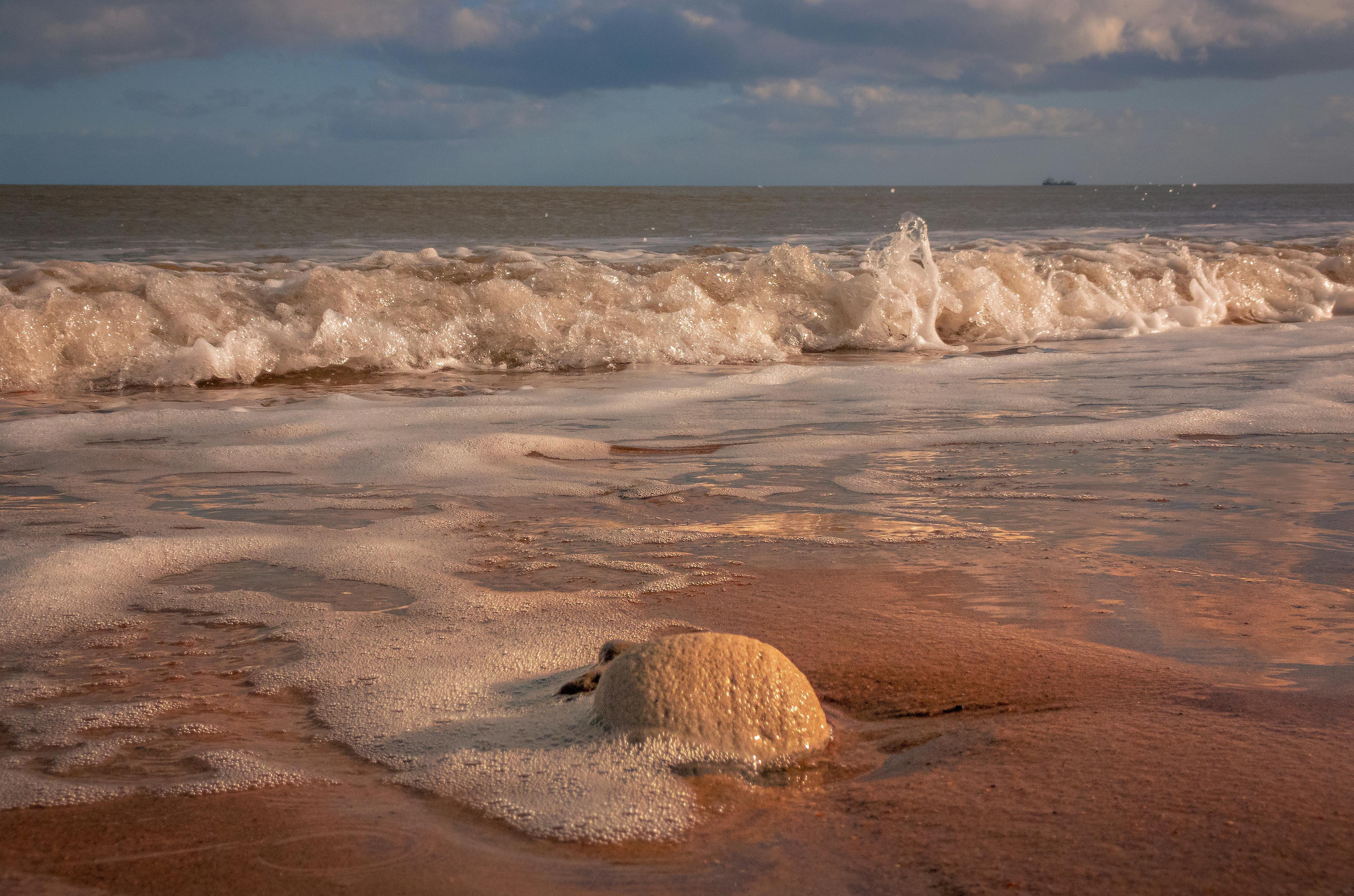 A White Rock on Seashore Near Crashing Waves · Free Stock Photo