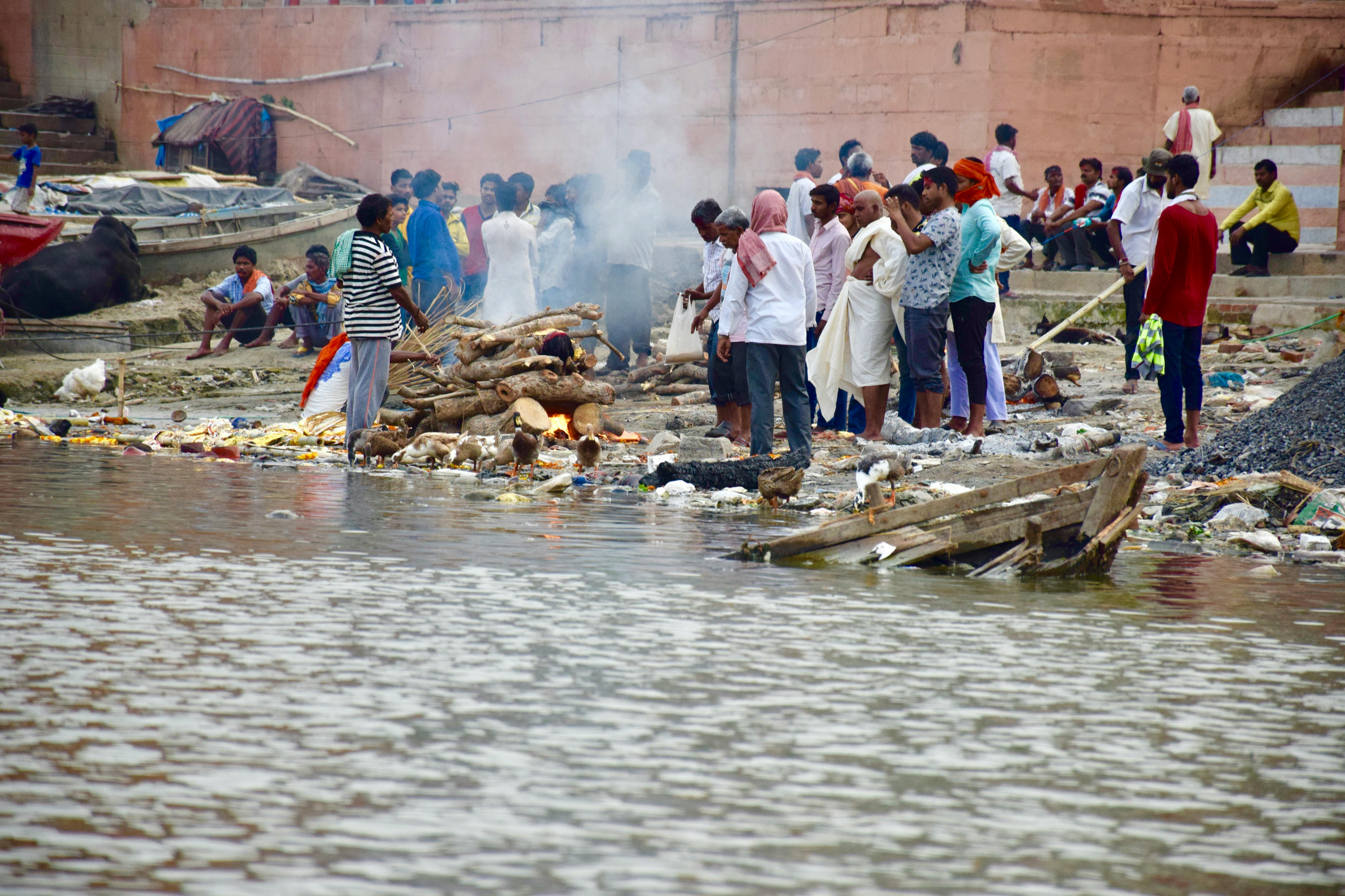 People on Riverbank in Town · Free Stock Photo