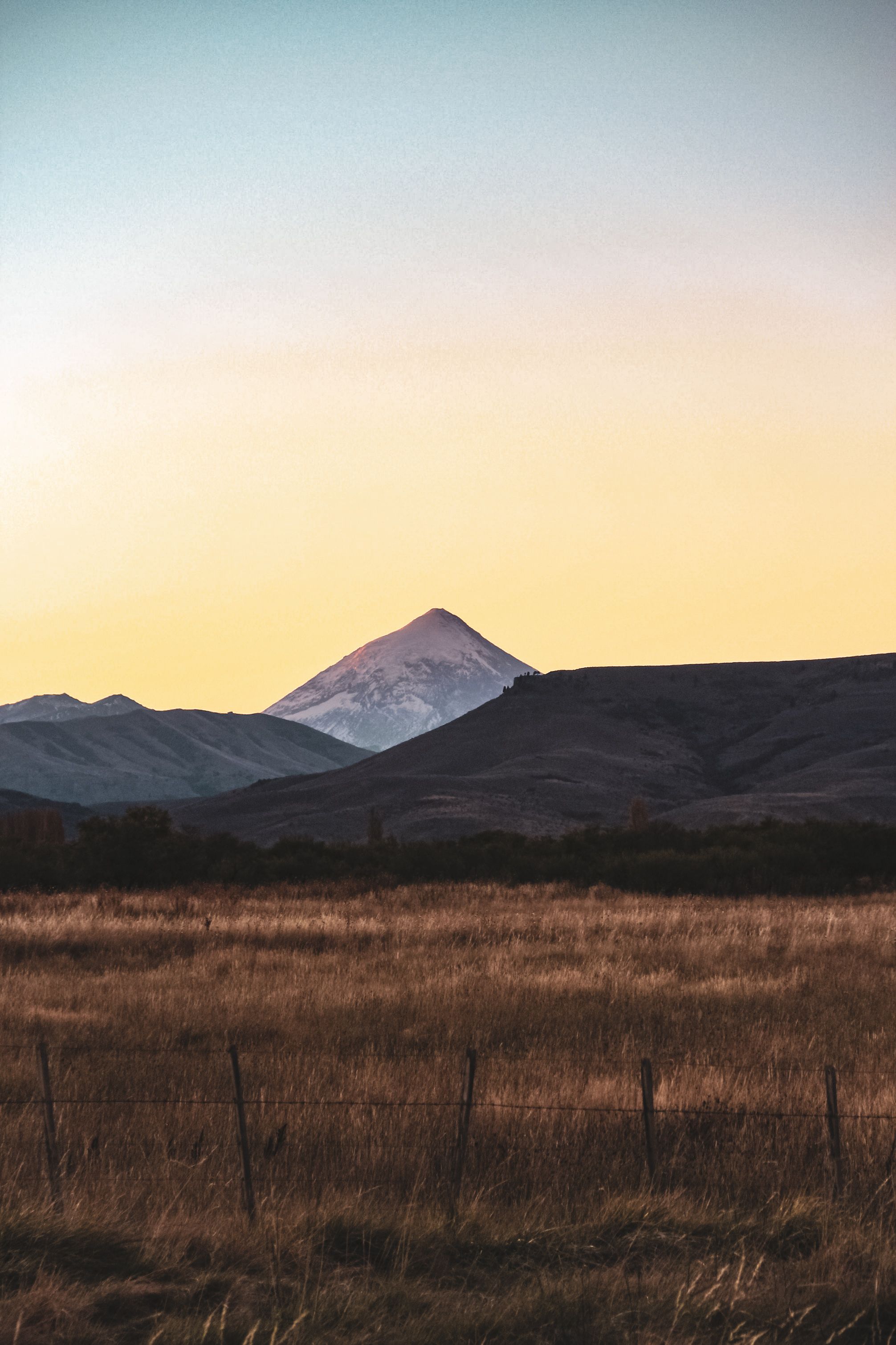 Grass Field Near Mountain · Free Stock Photo