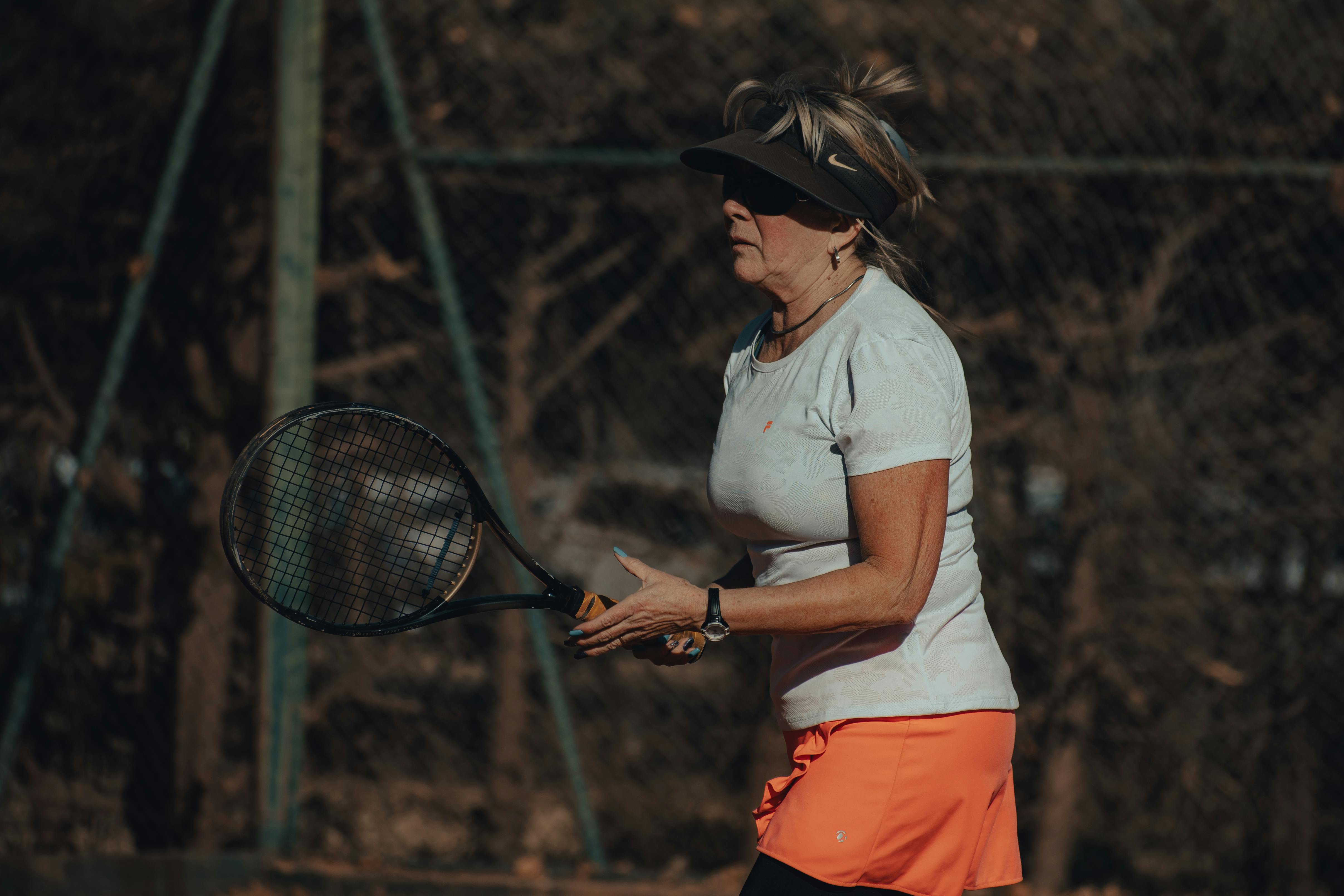 Curly Haired Woman Covering Her Face With Tennis Racket · Free Stock Photo