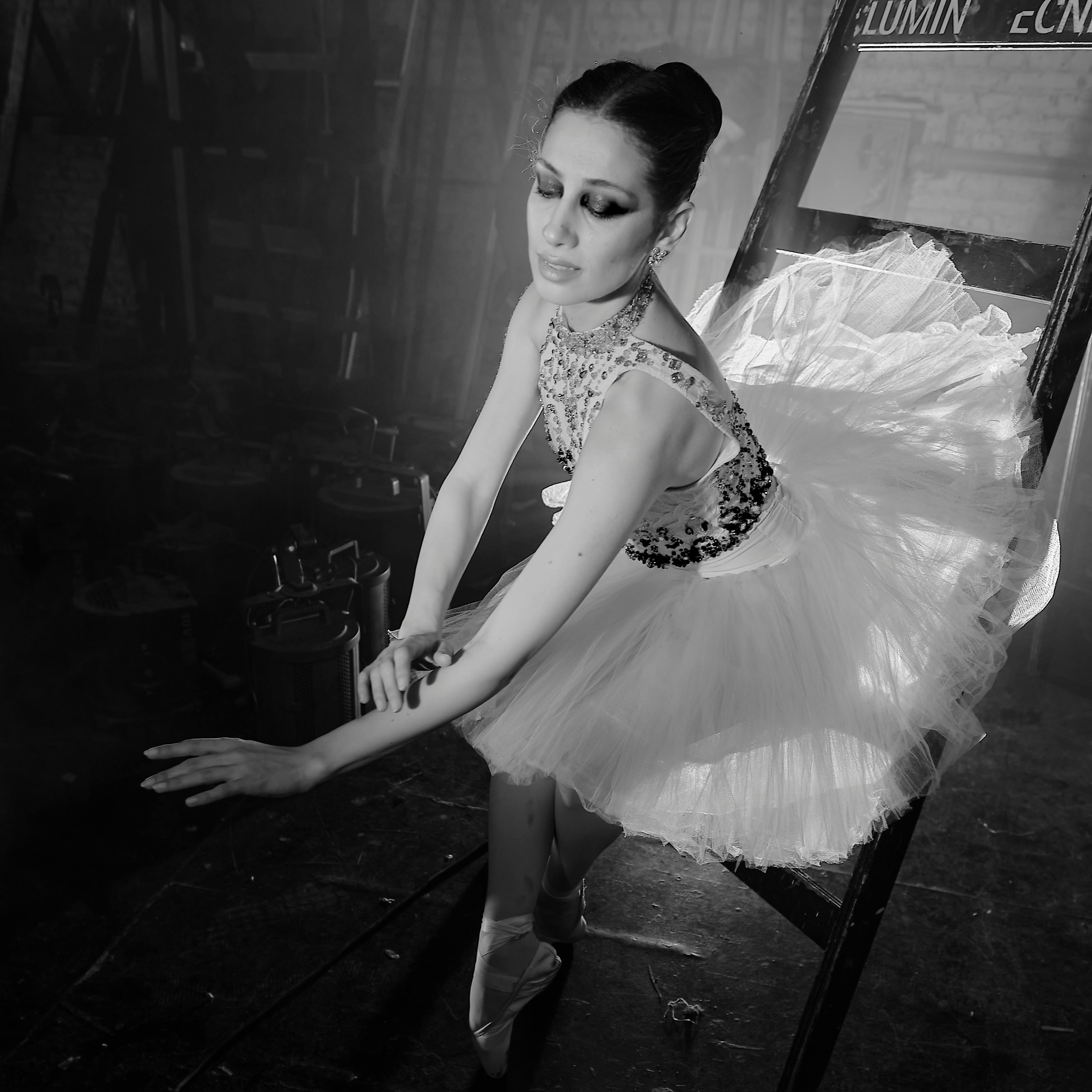 Unrecognizable ballerina touching door in darkness · Free Stock Photo
