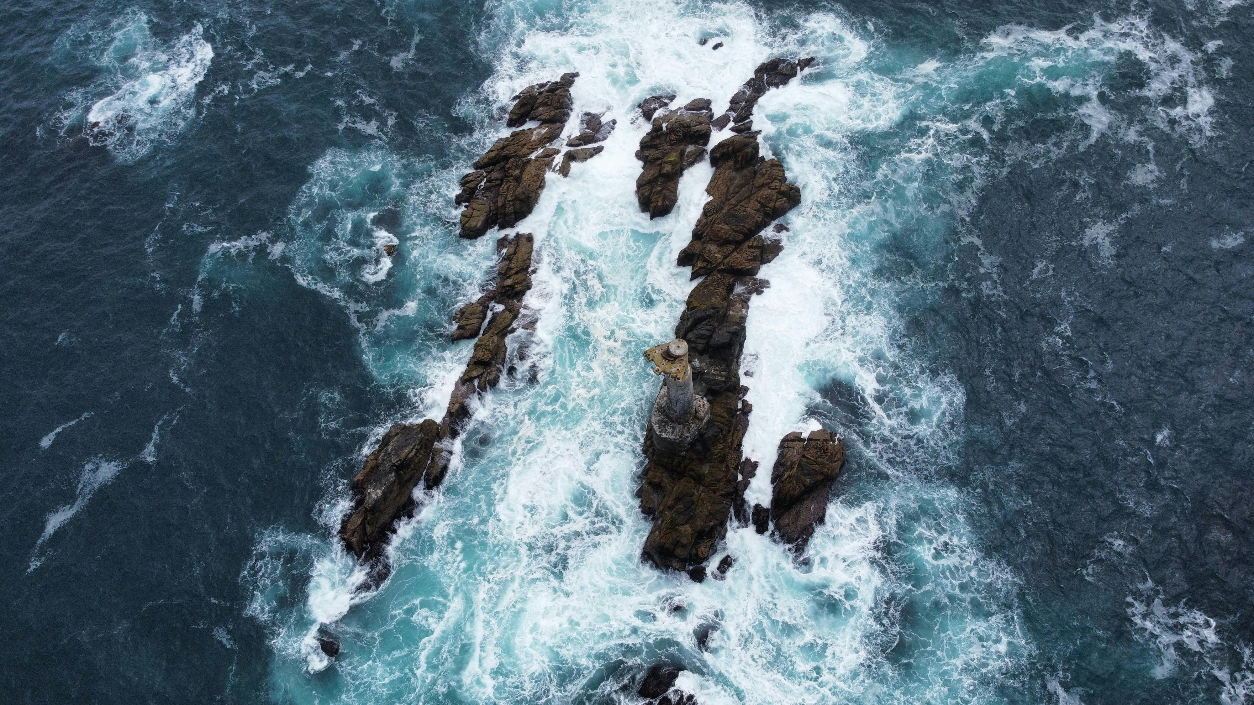 An Aerial Photography of Ocean Waves Crashing on Rock Formations · Free ...