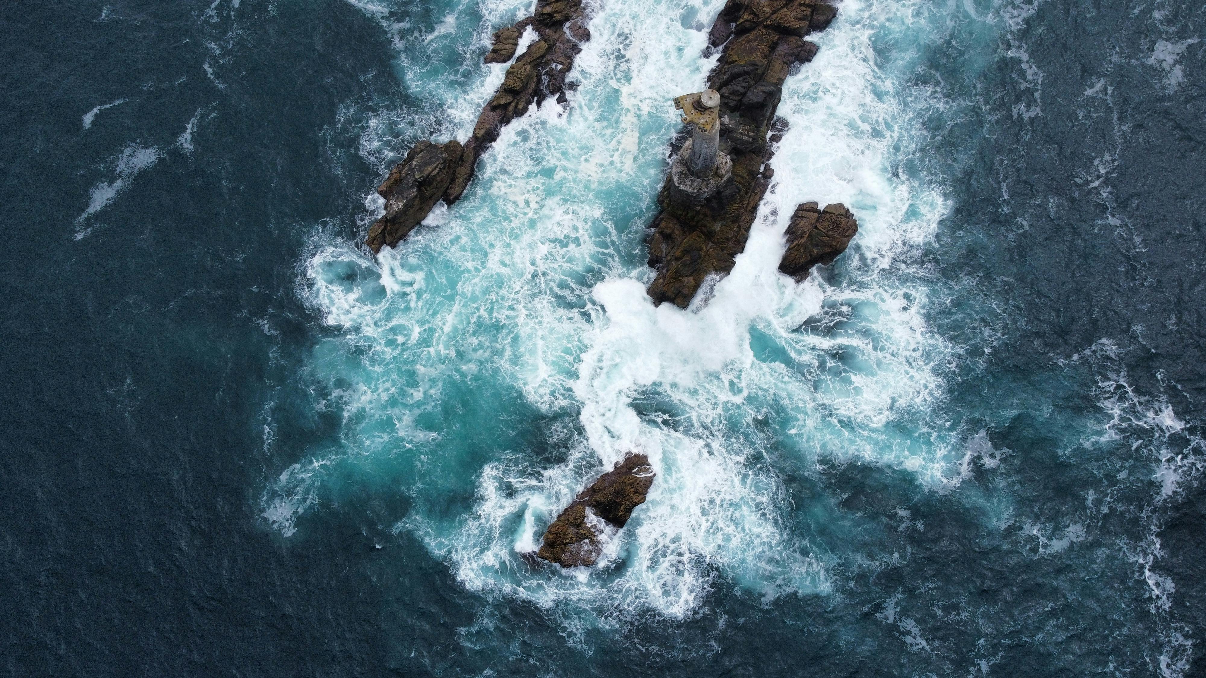 An Aerial Photography of Ocean Waves Crashing on Rock Formations · Free ...