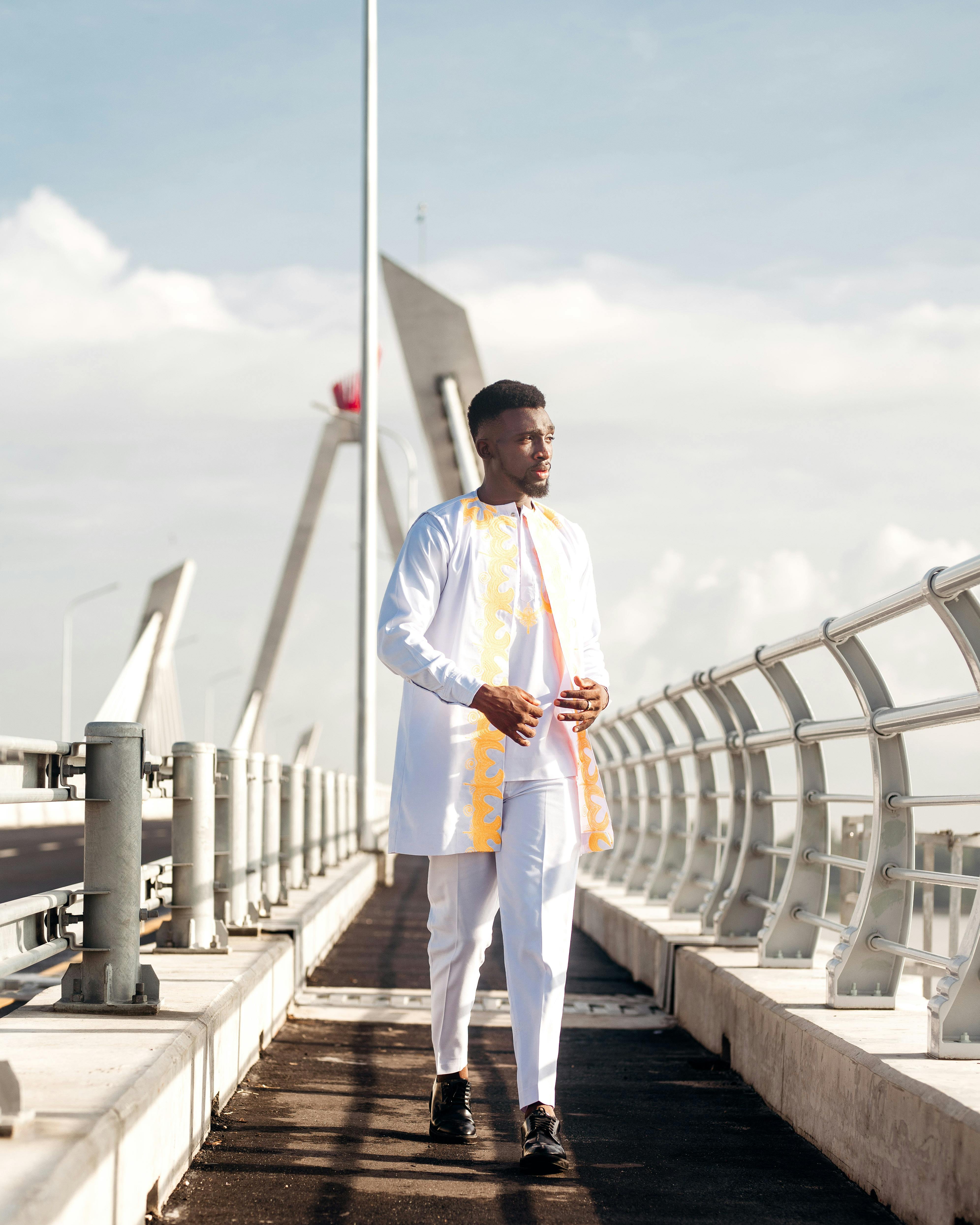 Male Fashion Model Walking Along Harbor Footpath · Free Stock Photo
