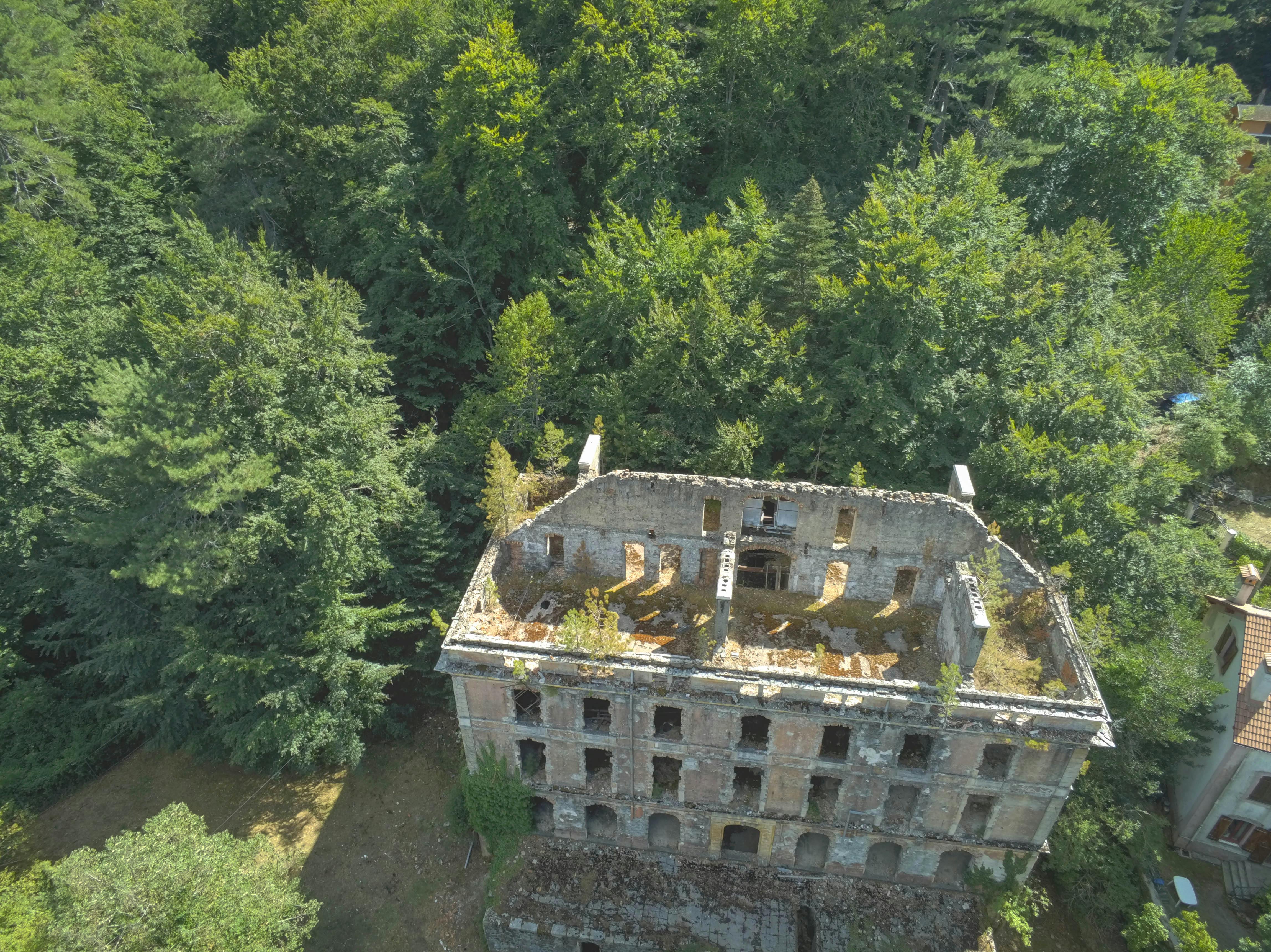 Aerial Photography of an Old Concrete Building near Green Trees in the ...