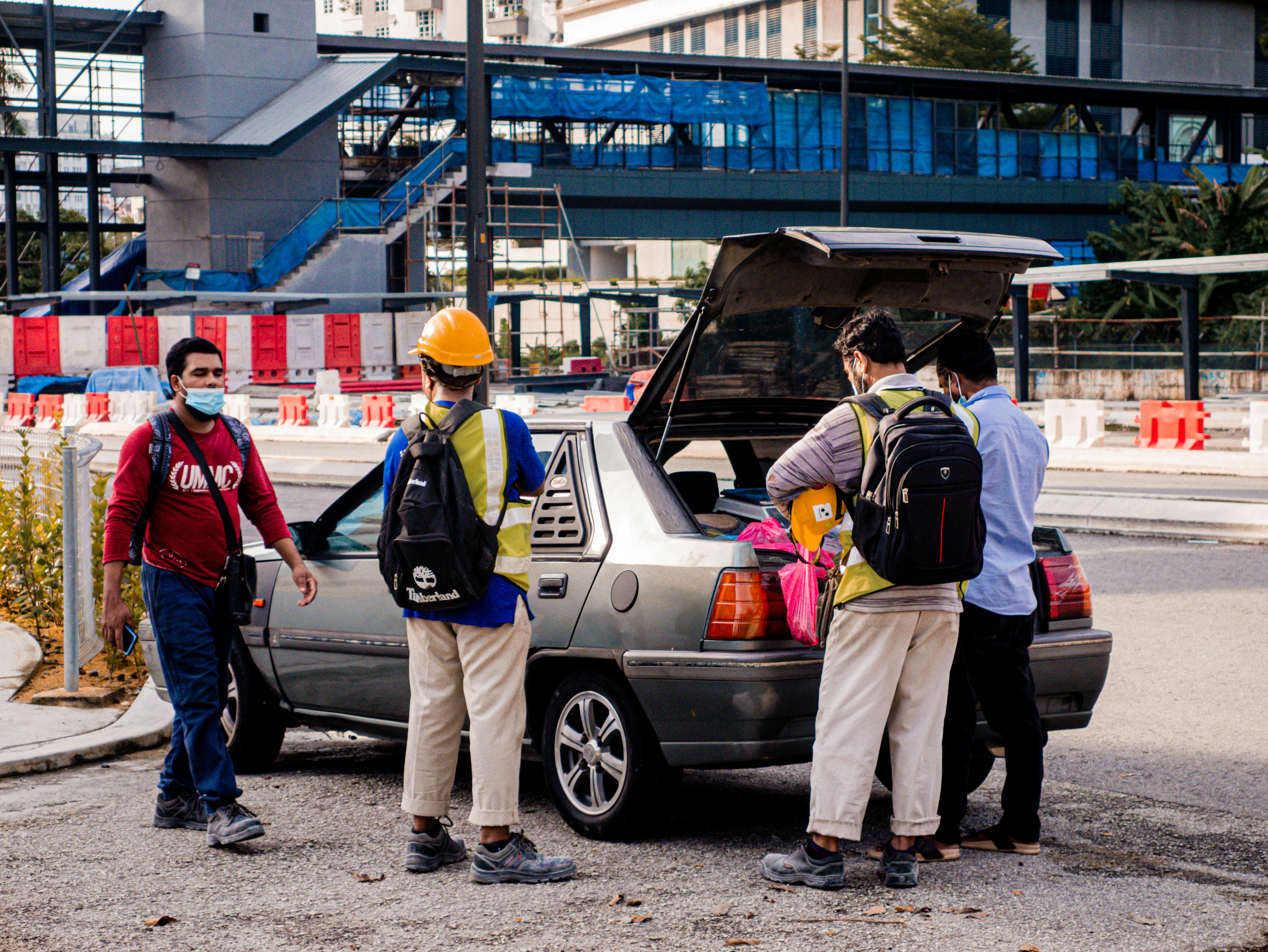 People Packing Items into the Trunk of a Car · Free Stock Photo
