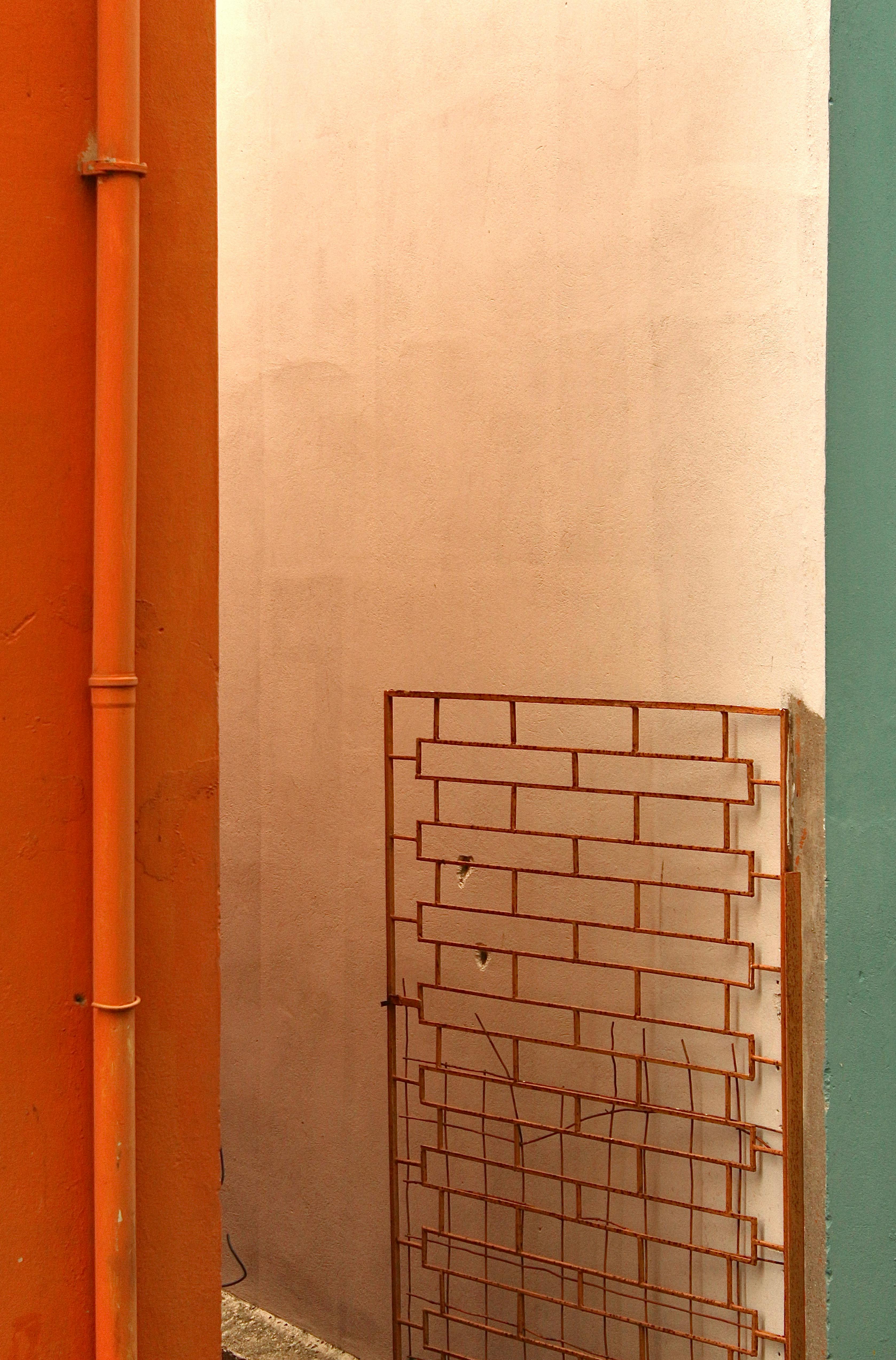 Brown Gate beside White Wall · Free Stock Photo